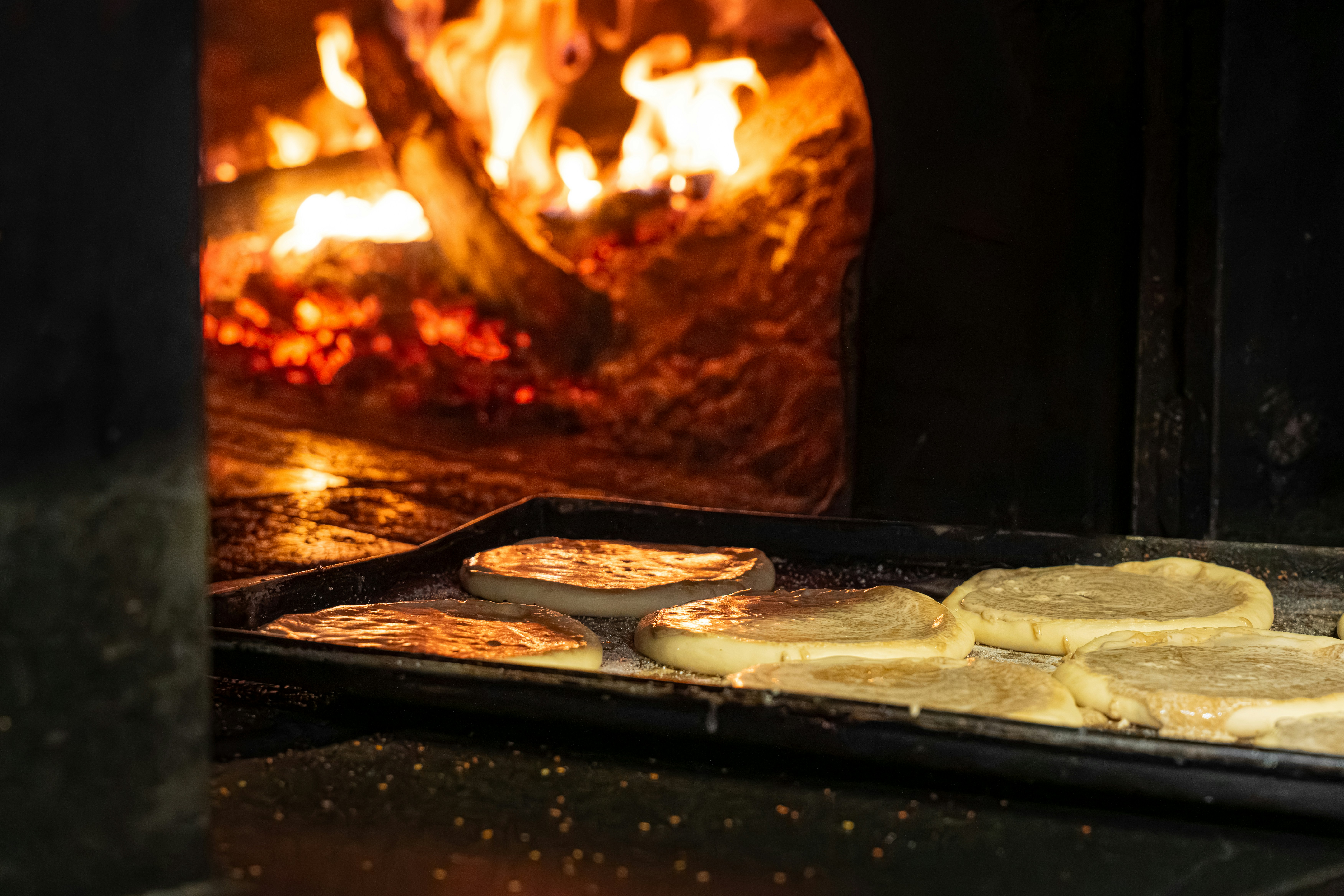 Firelit Bakery: Dough Rounds Baking on the Ember Tray