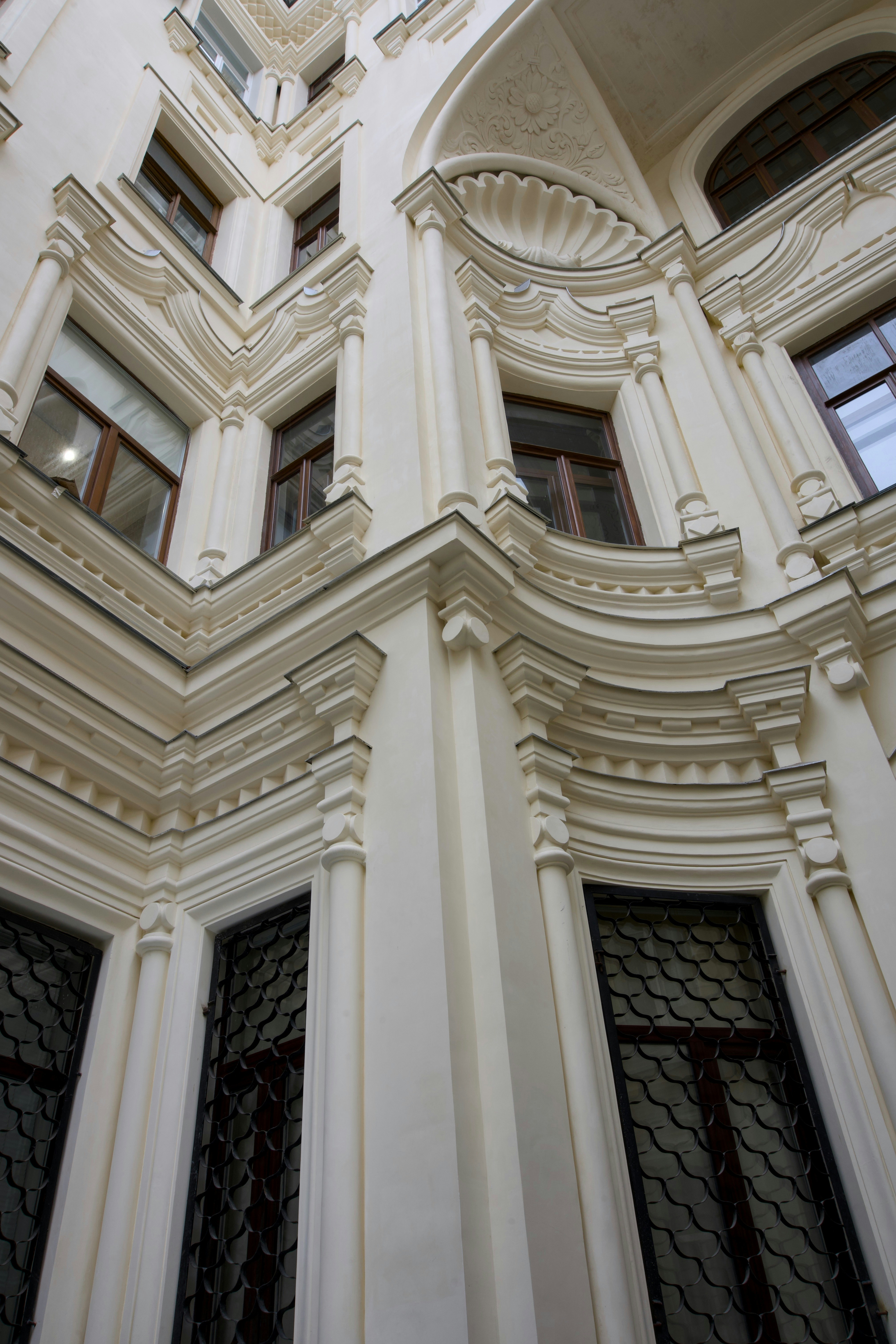 Ornate Facade: Sunlit Curves and Carved Columns