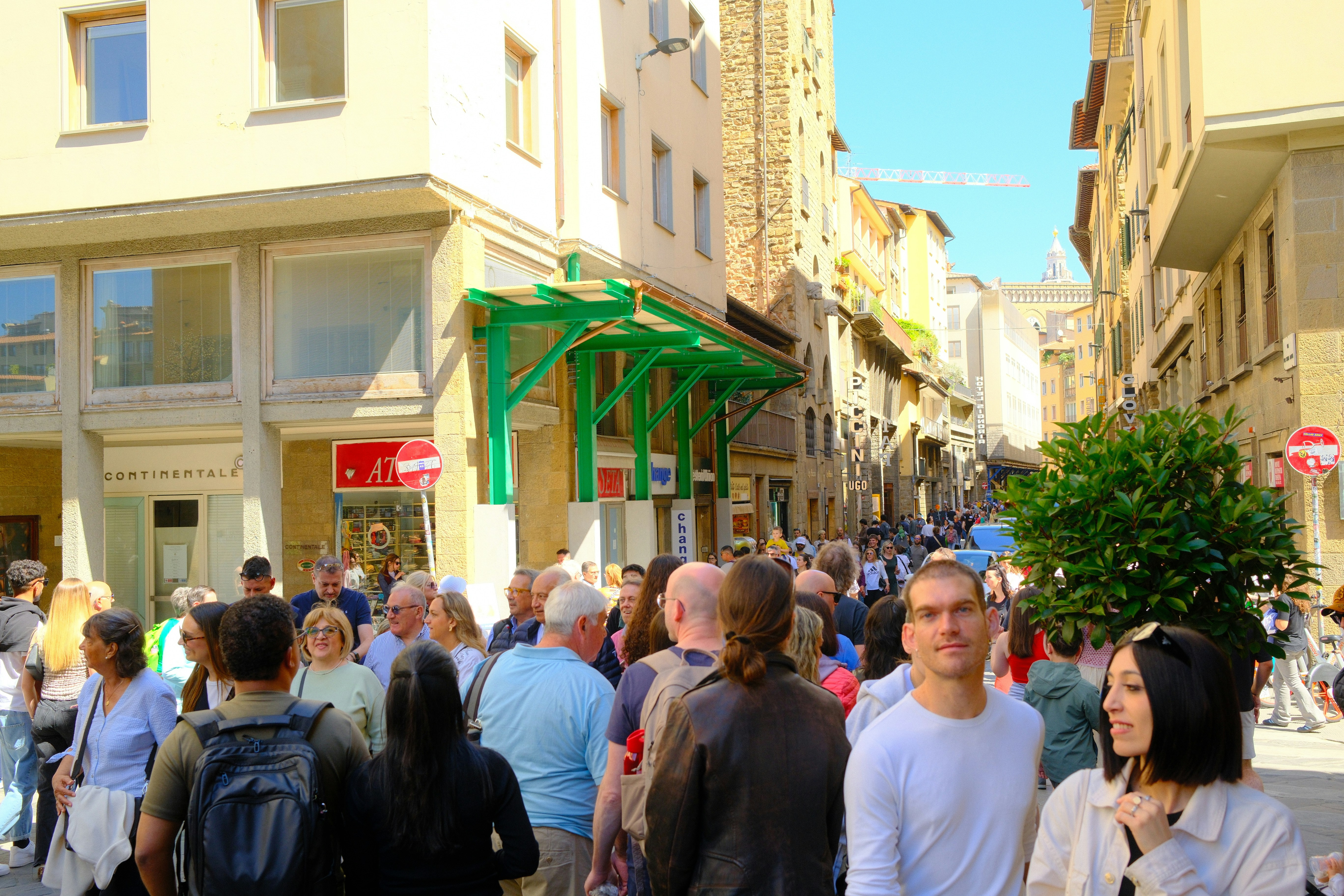 Crowd Corner: A Sunlit Street Alive with Faces