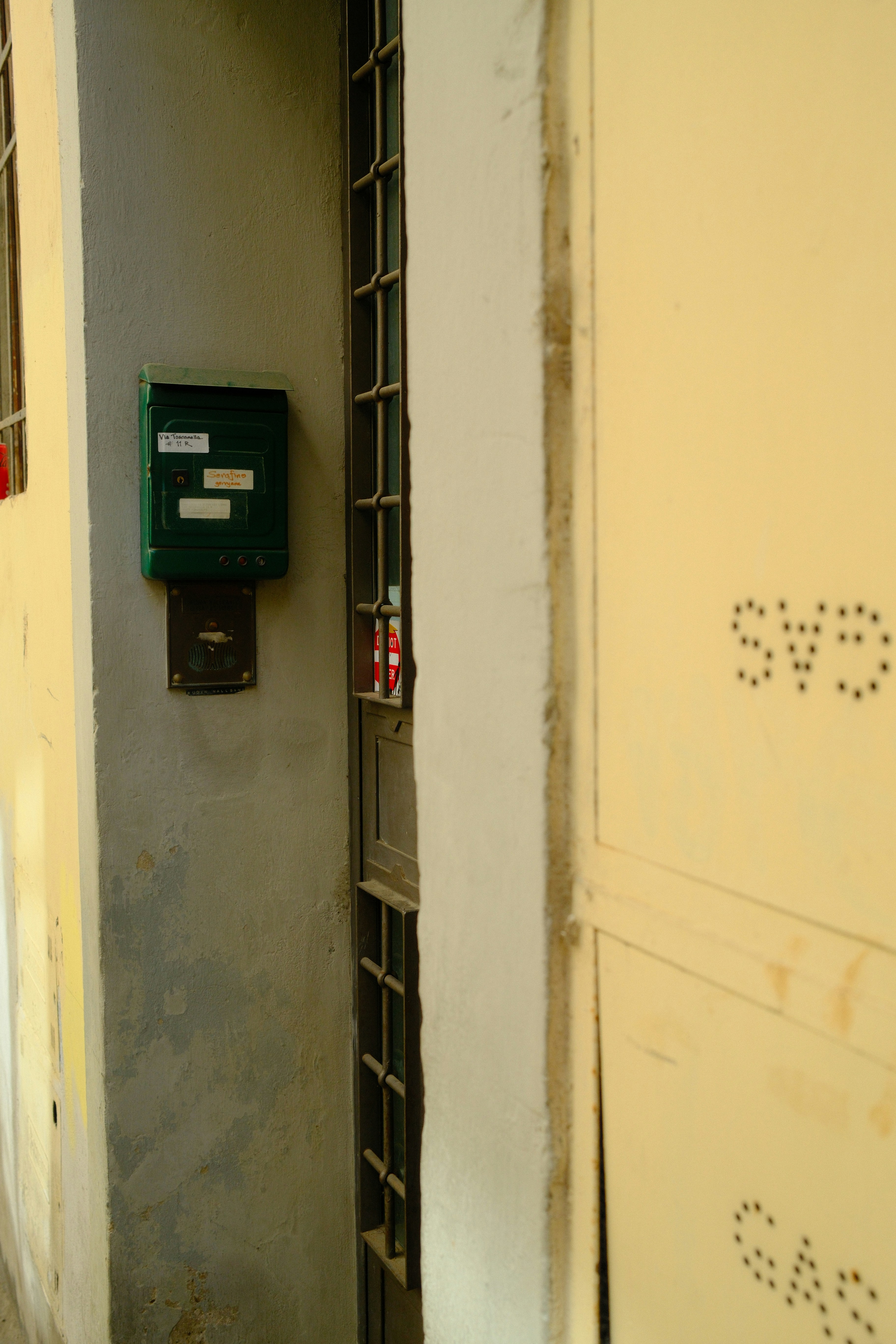 Muted doorway corridor: a street-side palette of yellows and greens