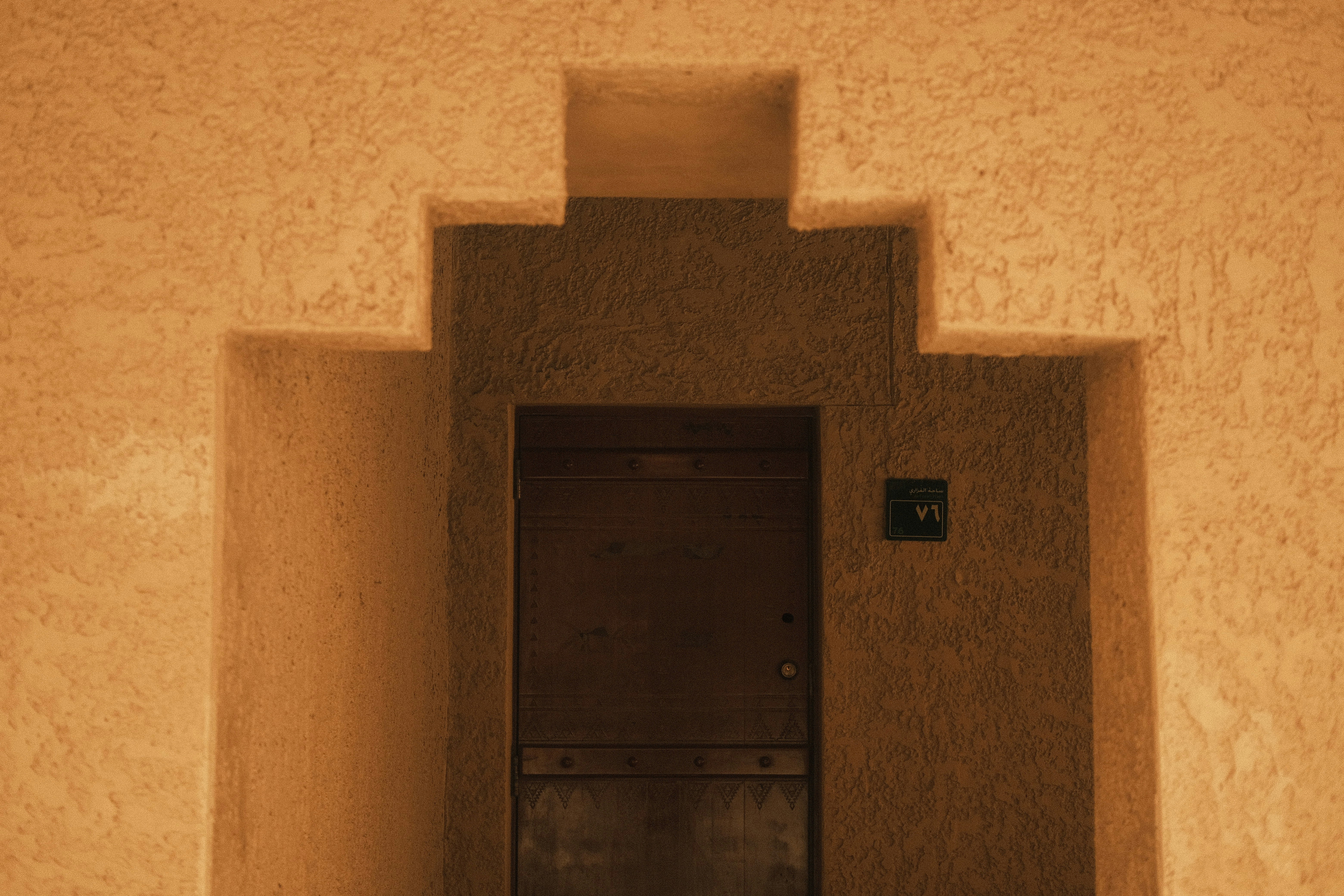 Deserted Archway: A Sun-Burnished Doorway Framed by Terracotta Steps