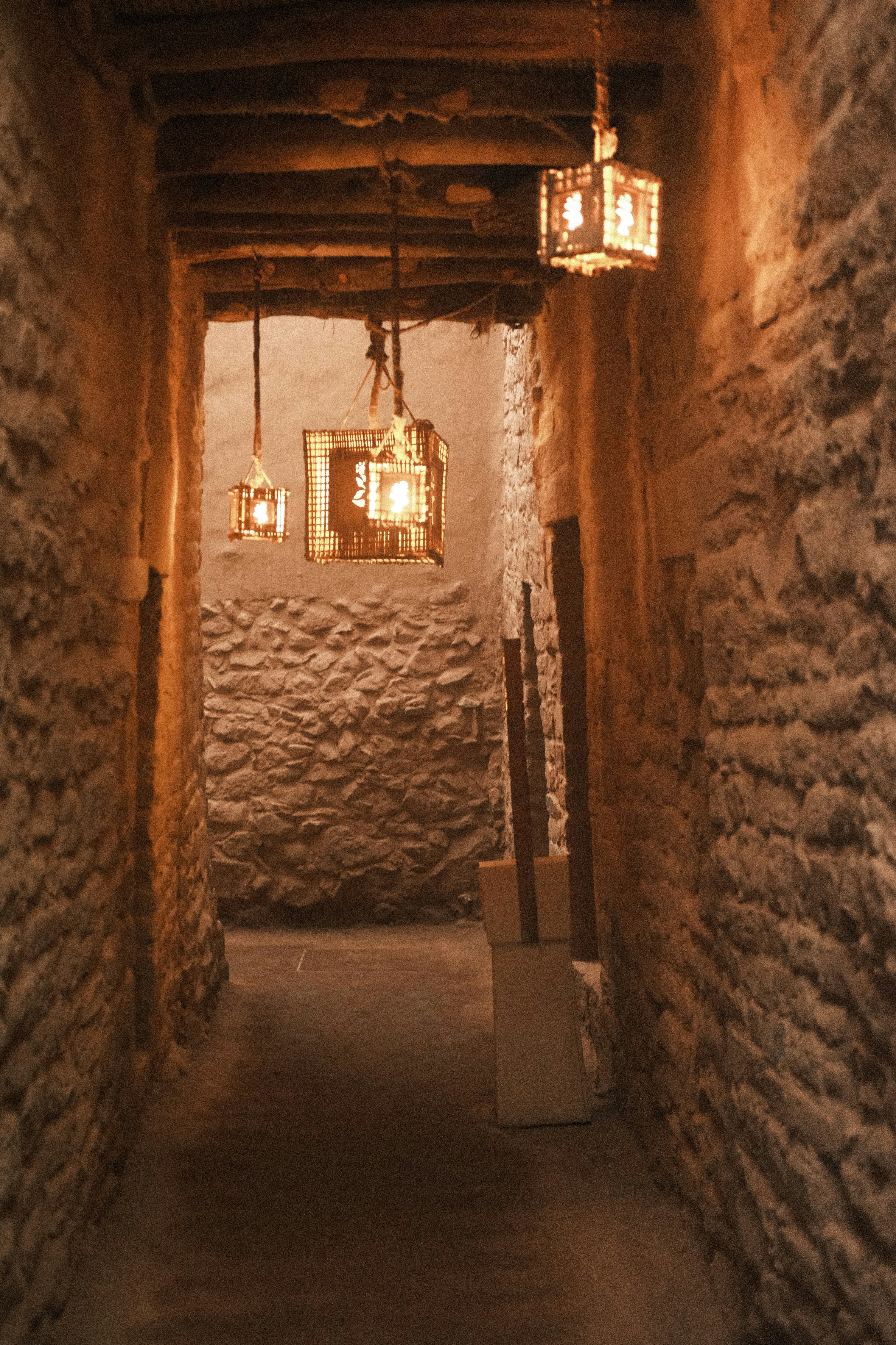Lantern-lit Passage: Warmth in a Stone Corridor