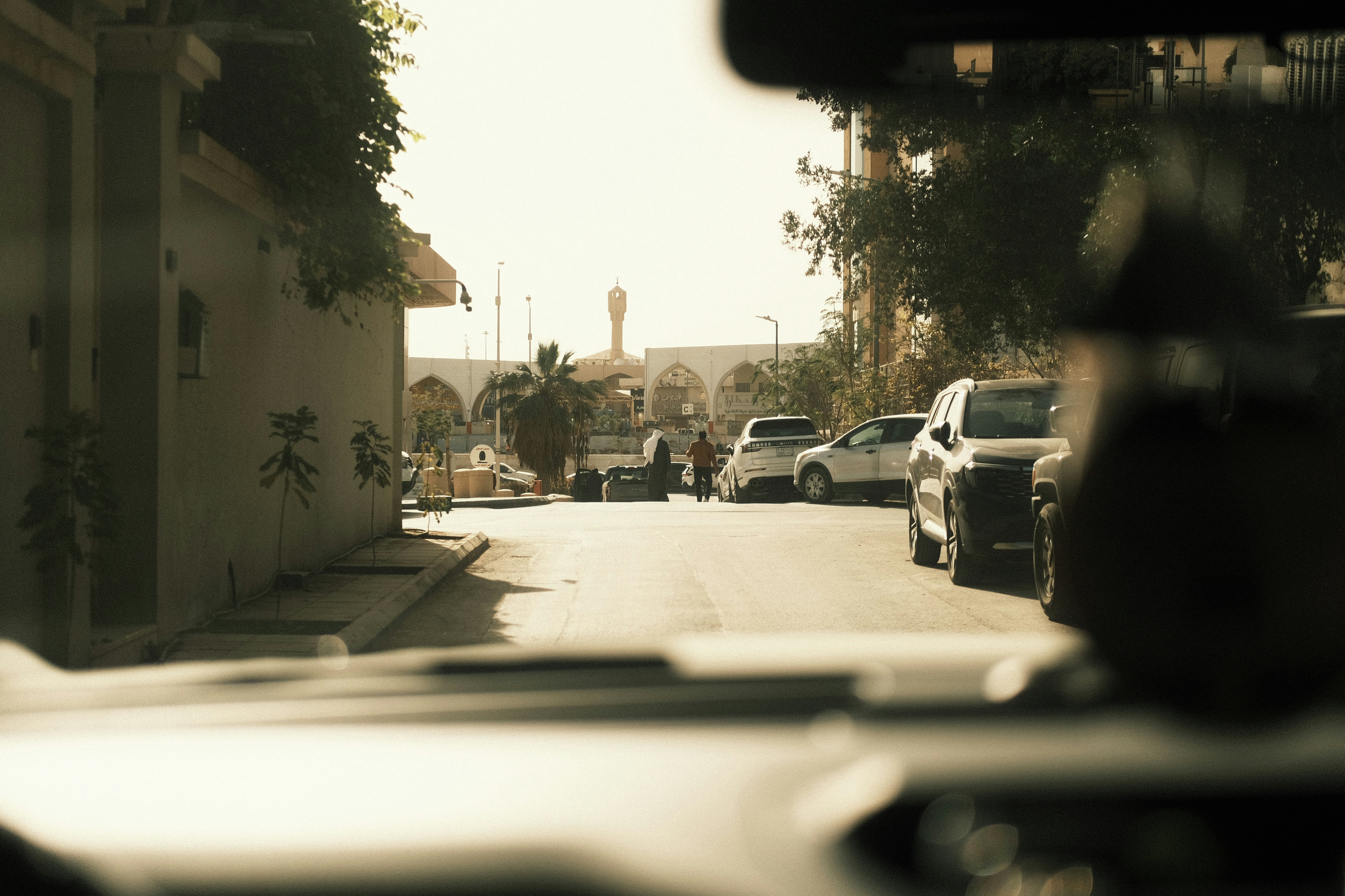 Midday Drive Toward a Distant Plaza