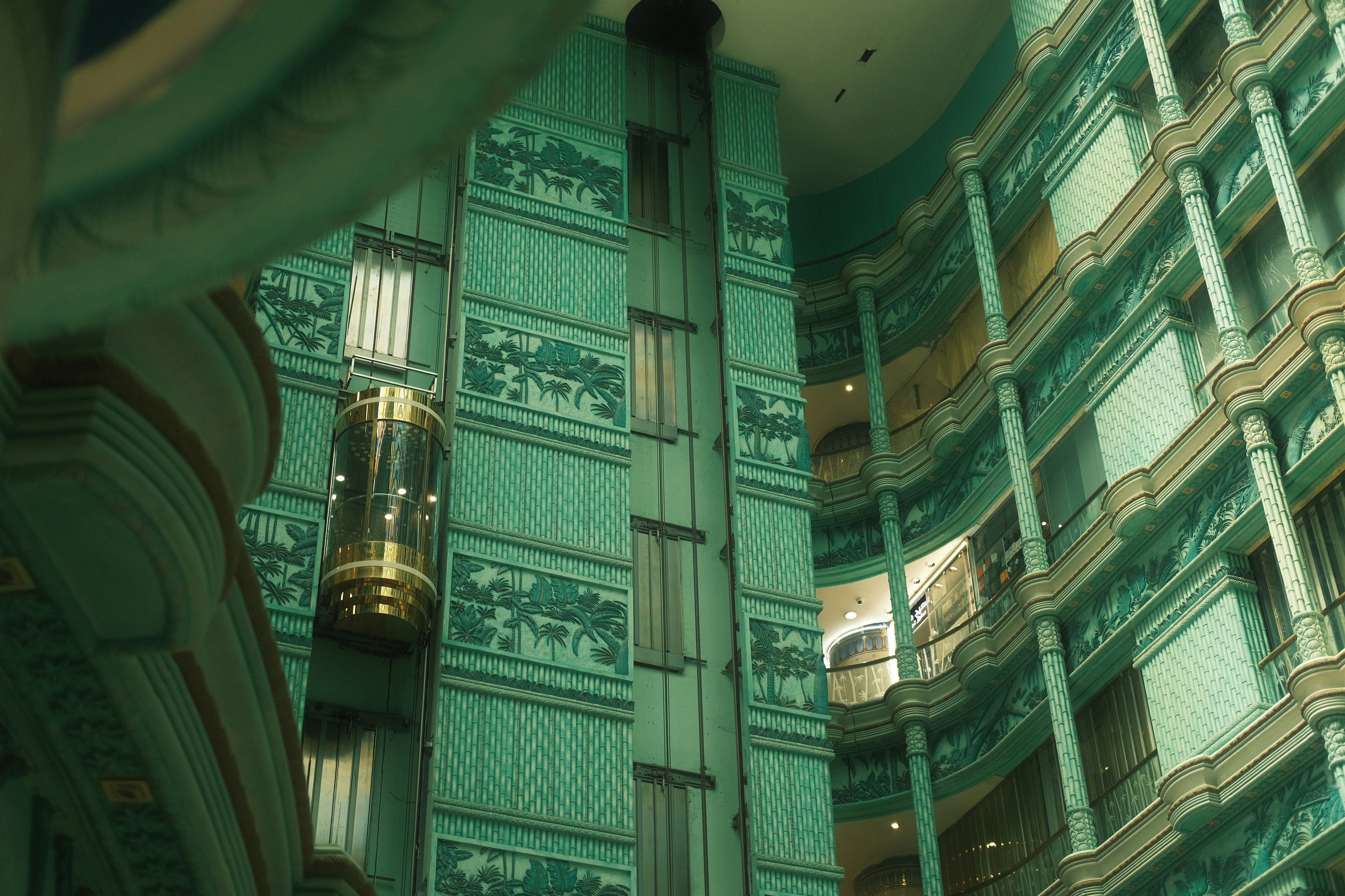 Emerald Atrium: Carved Facades and Circular Elevators