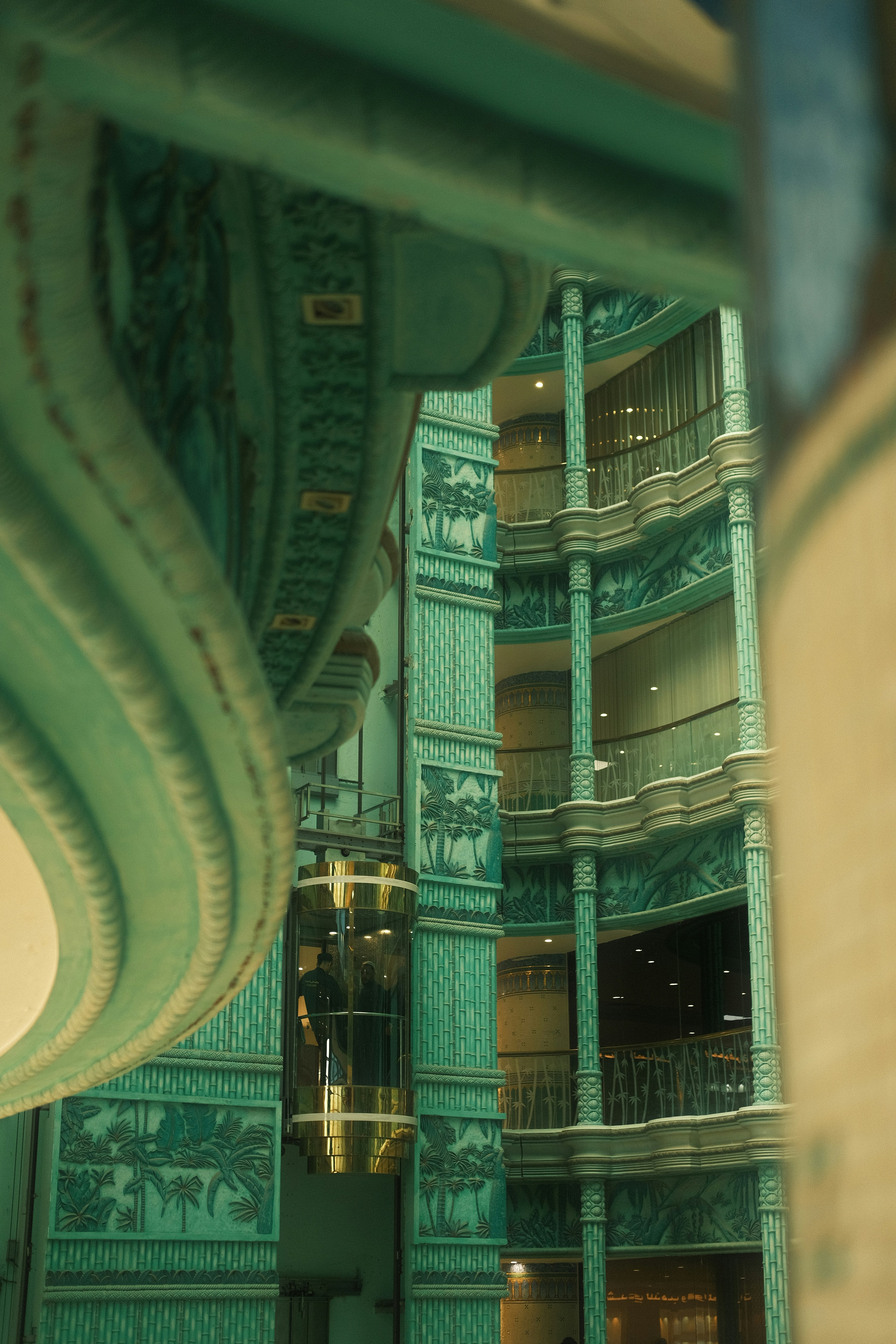 Vertical Atrium Spirals: Green Carved Light and Palm Columns