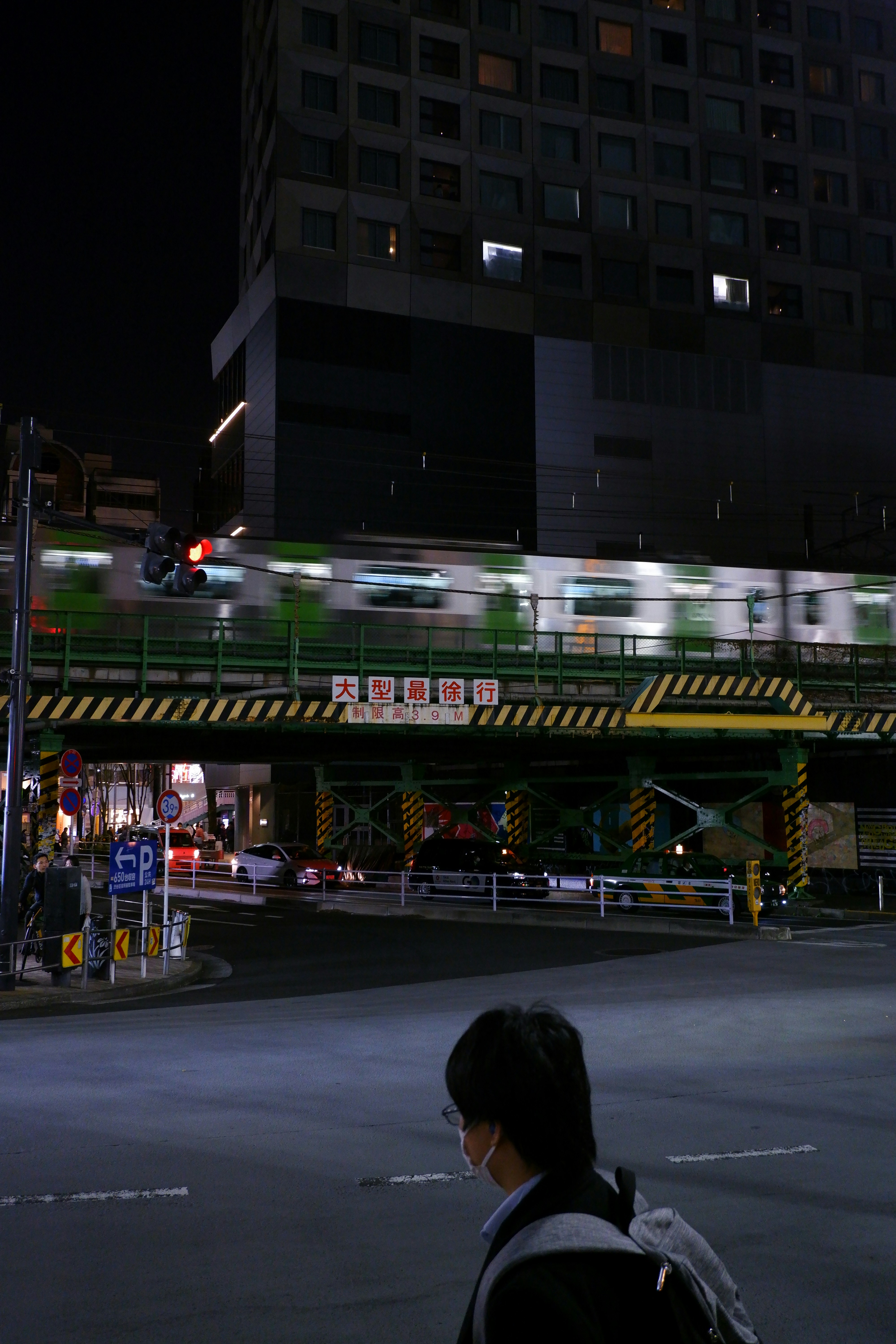 Night Train Overpass: A Quiet Street Scene with a Walking Figure