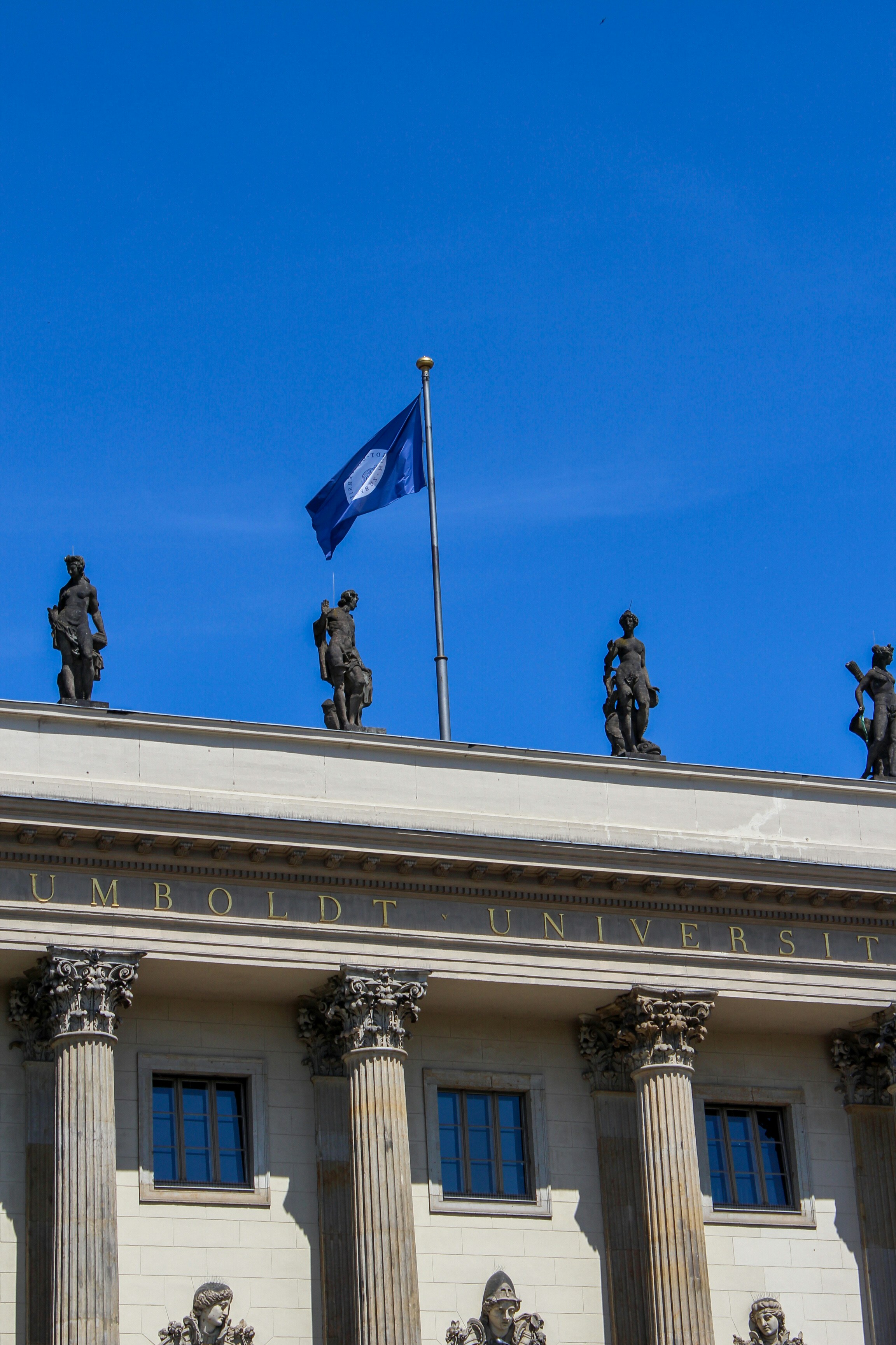 Flag Above the Classical Facade at a European University