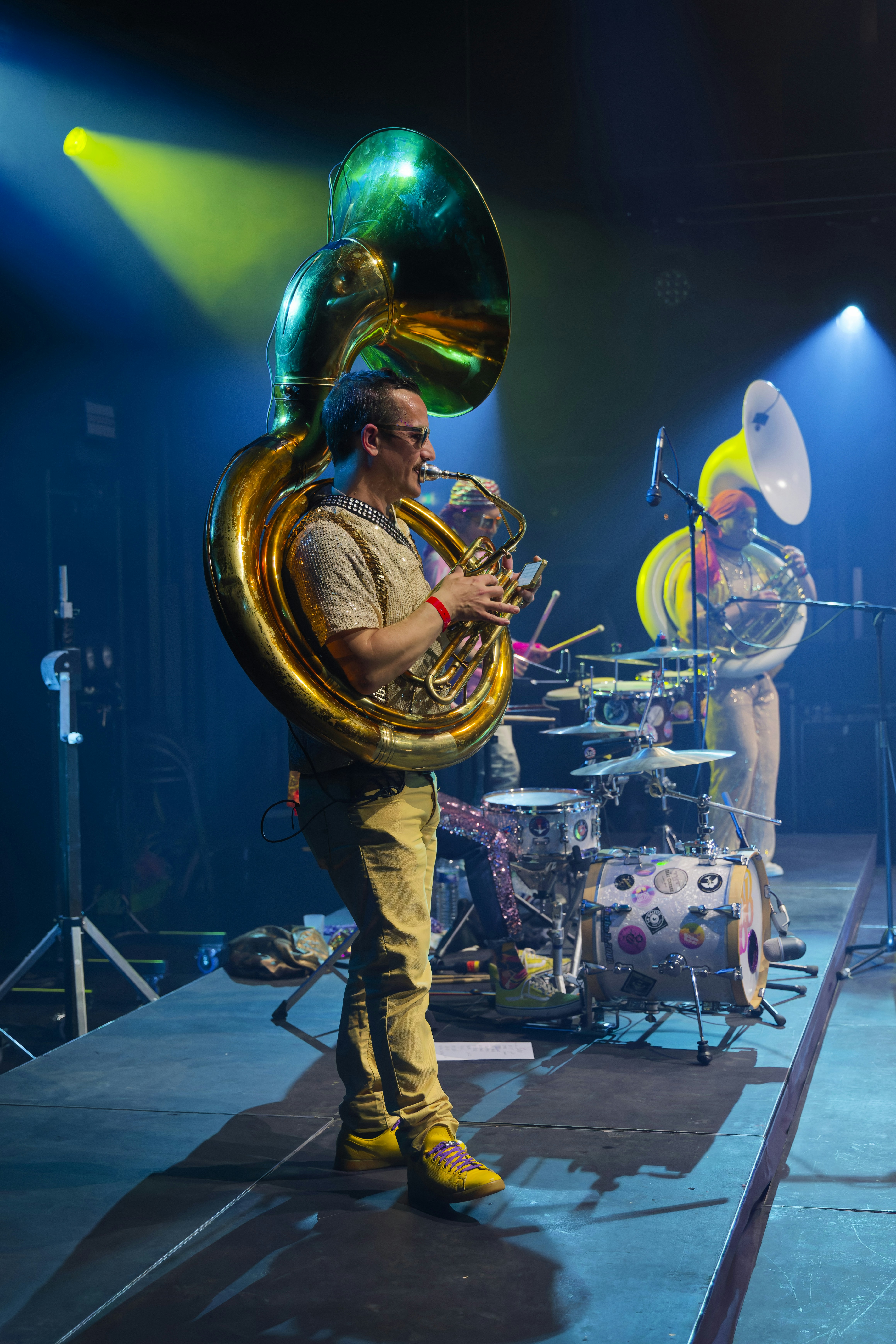 Brass on the Stage: A Soloist's Tuba and a Band in Neon