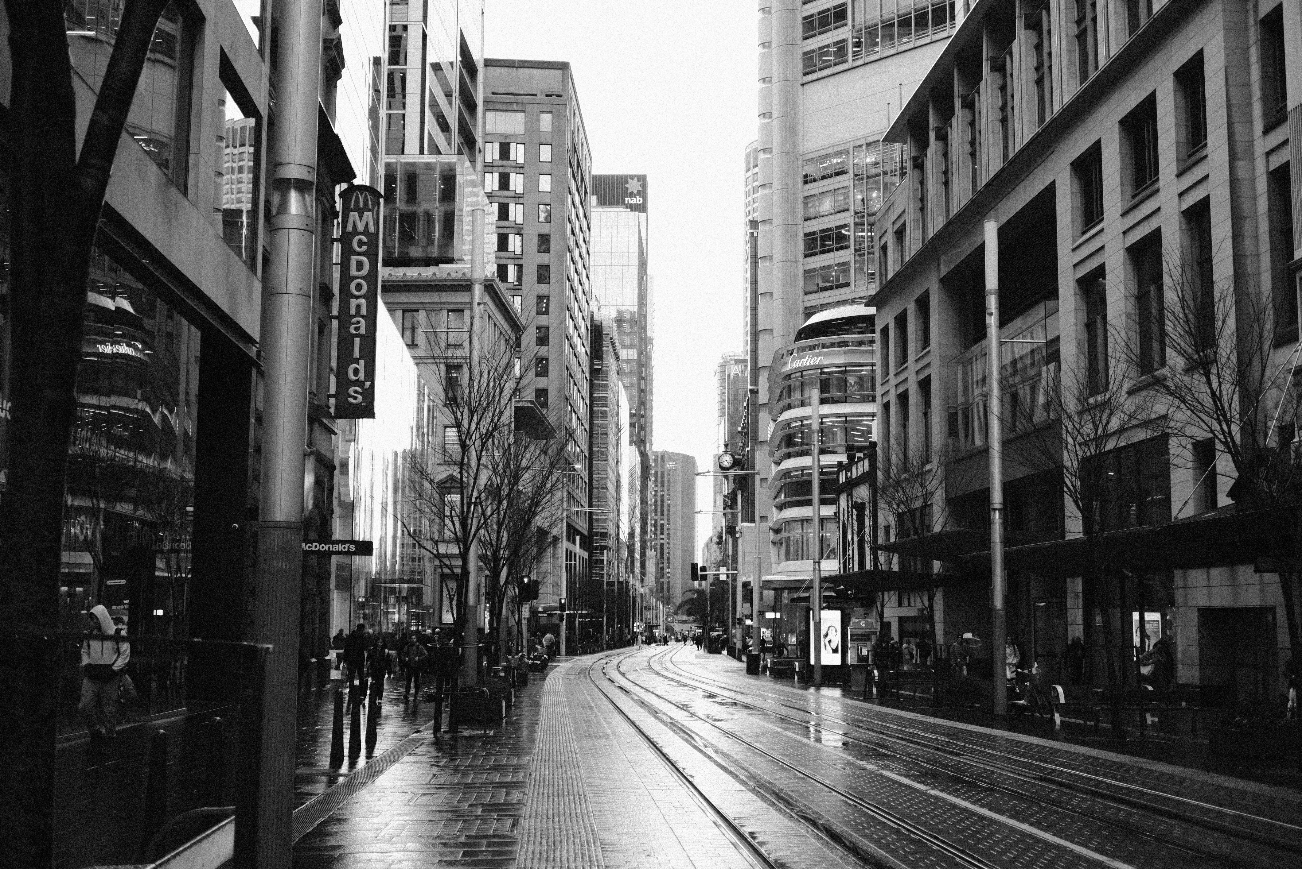 Urban Railcar Mirage: A Quiet Rainy Street in Monochrome