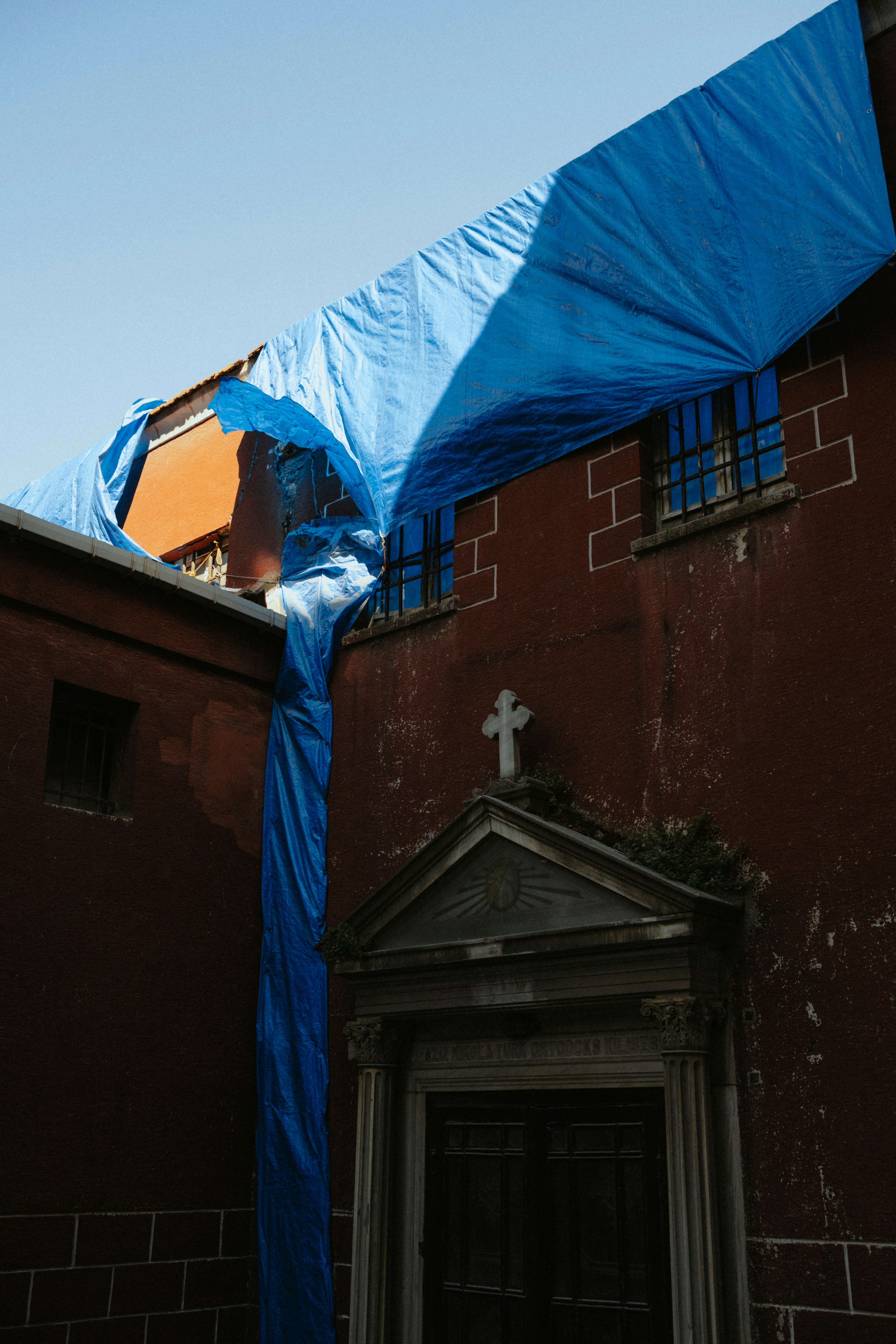 Blue Canvas on a Crimson Facade