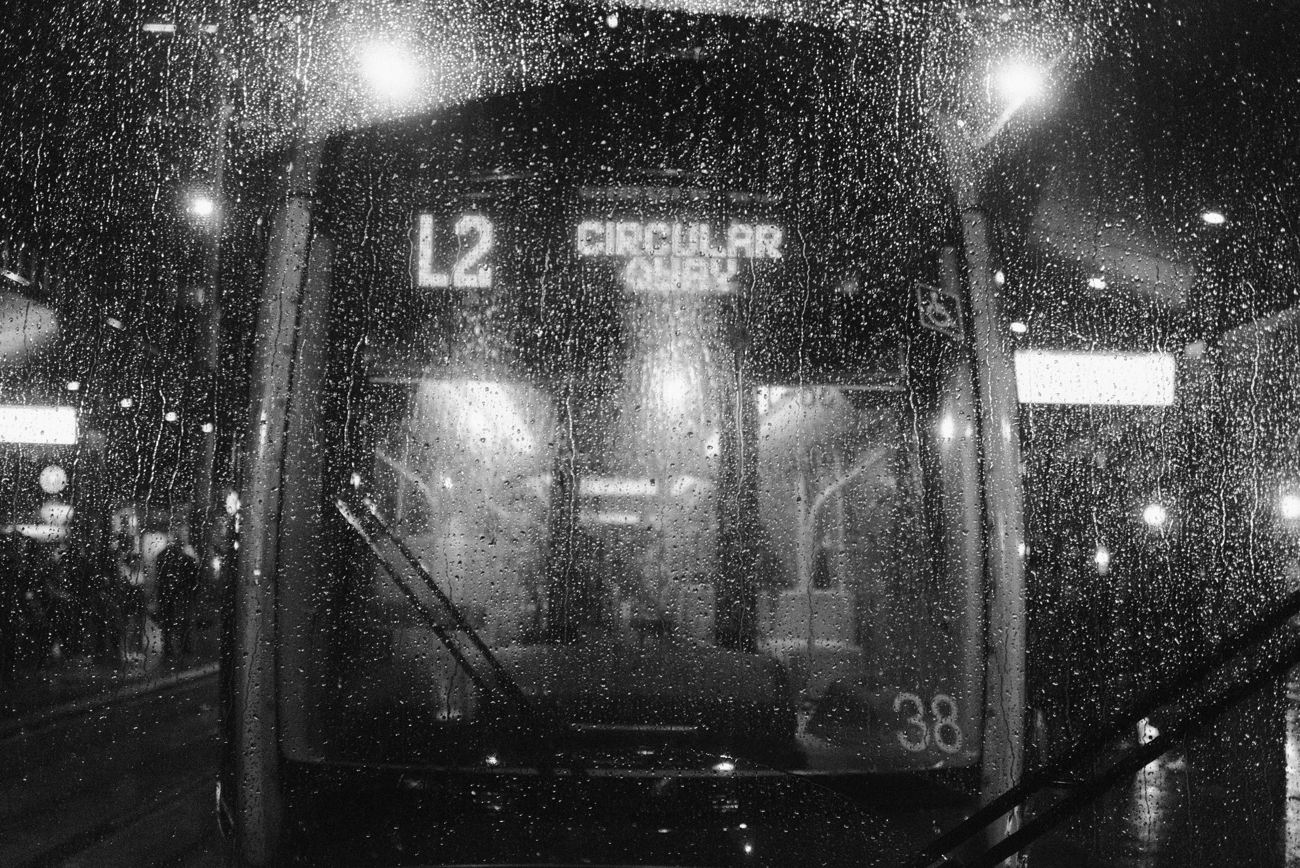 Night Bus Window: Rain-Streaked Glass Framing a Snowy Street