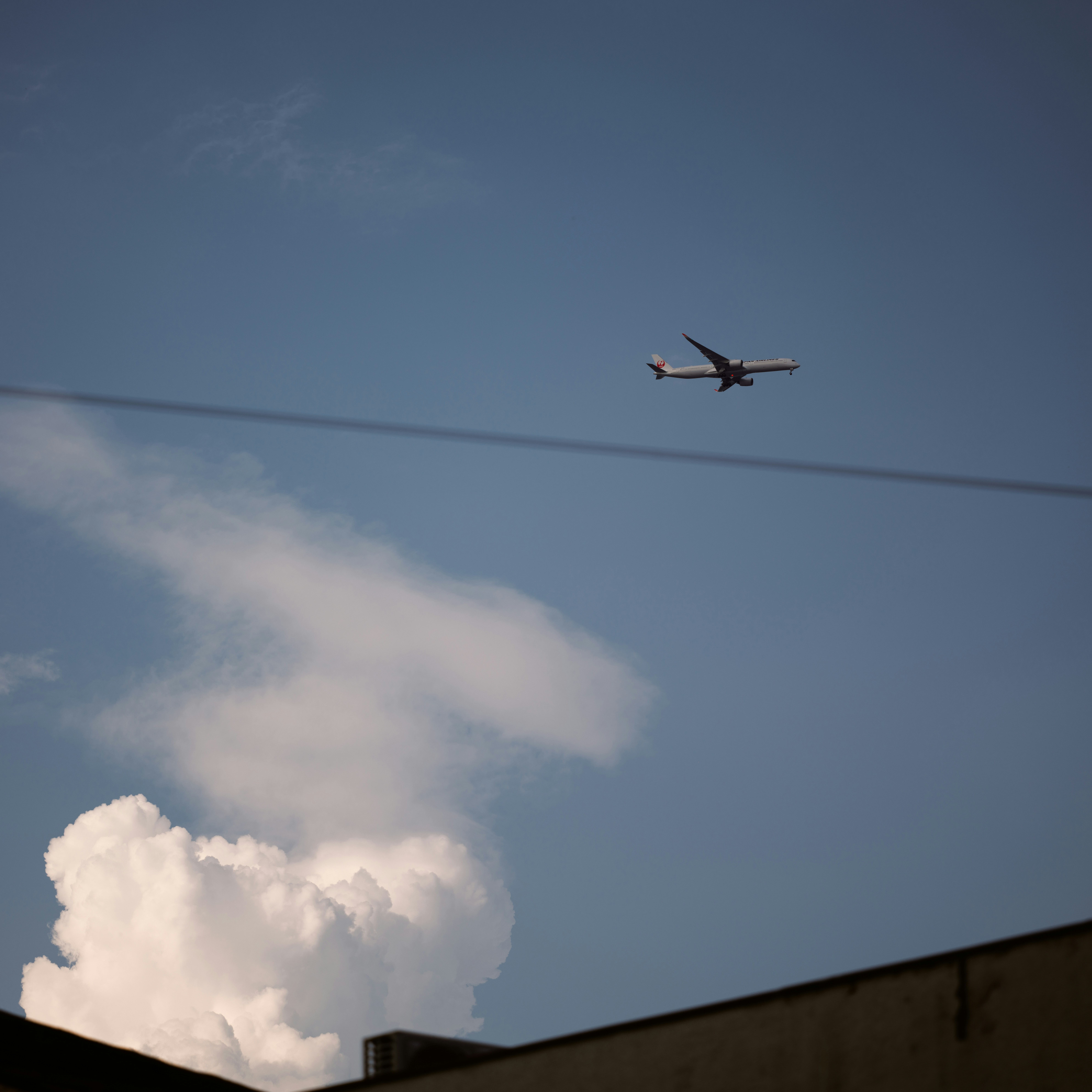 Mid‑air Crossing: A lone freighter against a sky-wash