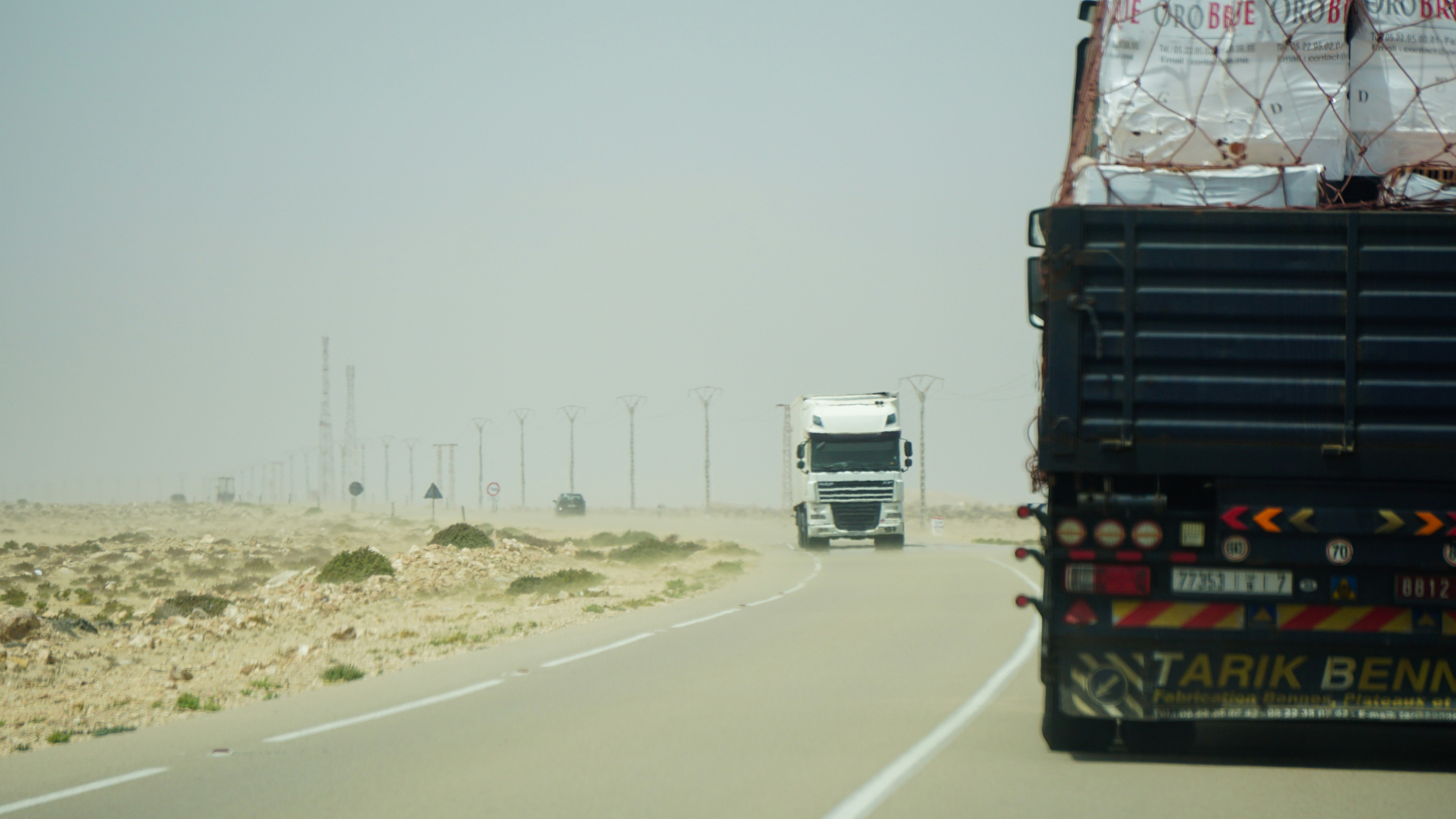 Trailing Trucks on a Desert Road Distant Horizon