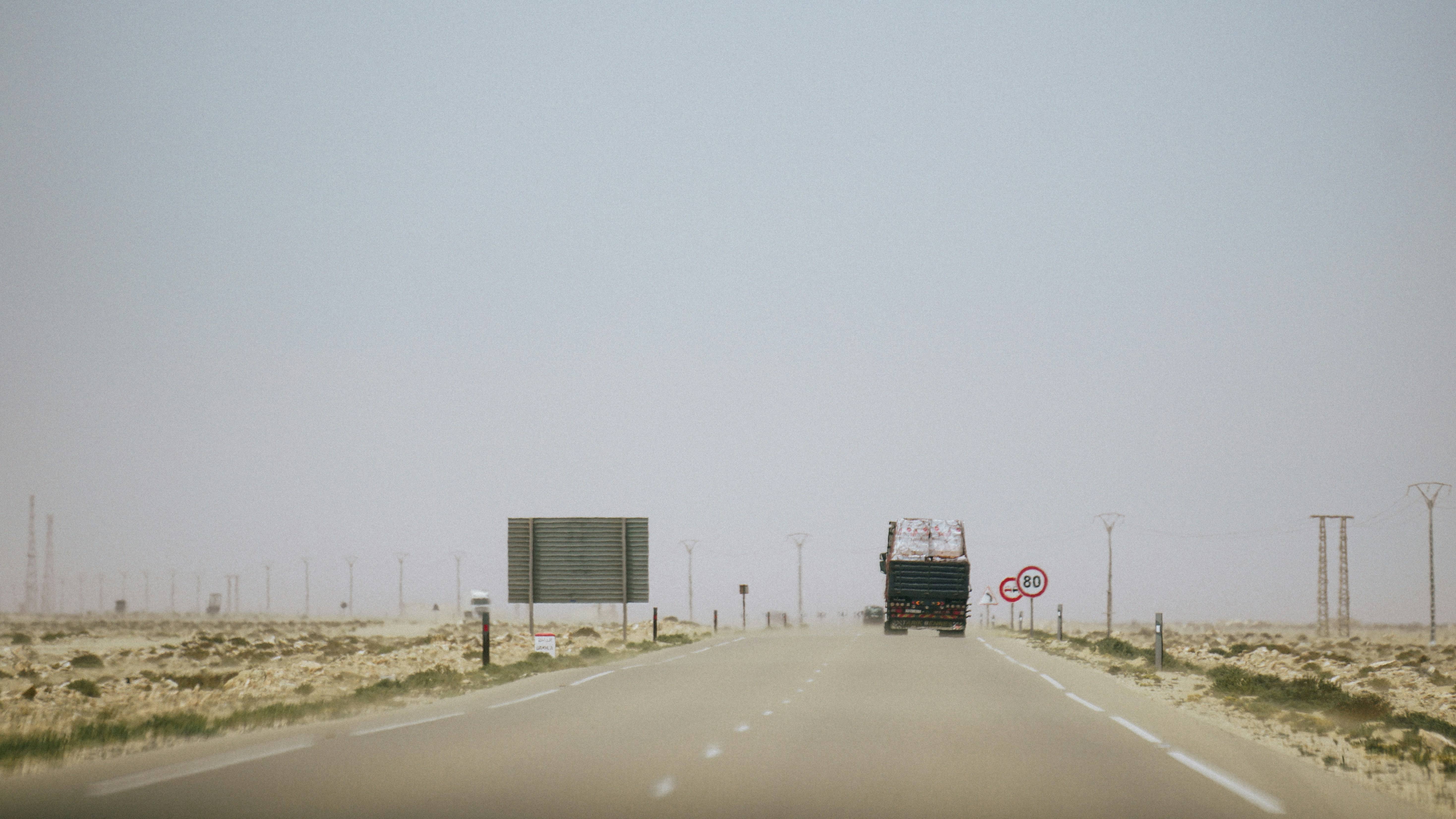 Desert Highway: The Lone Truck on a Sunlit Stretch