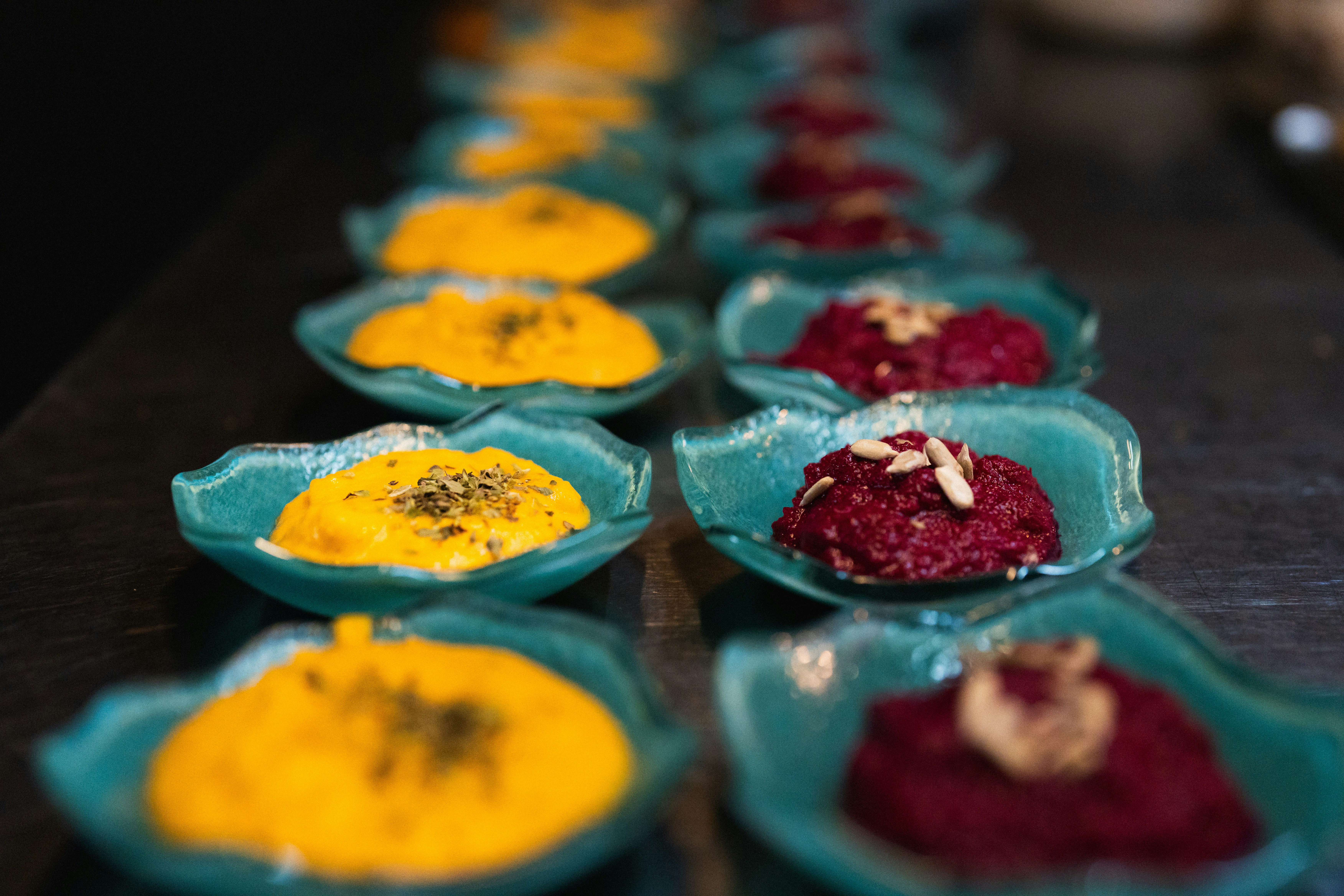 Colorful Mezze in Turquoise Ramen-Like Dishes Line a Wooden Tray