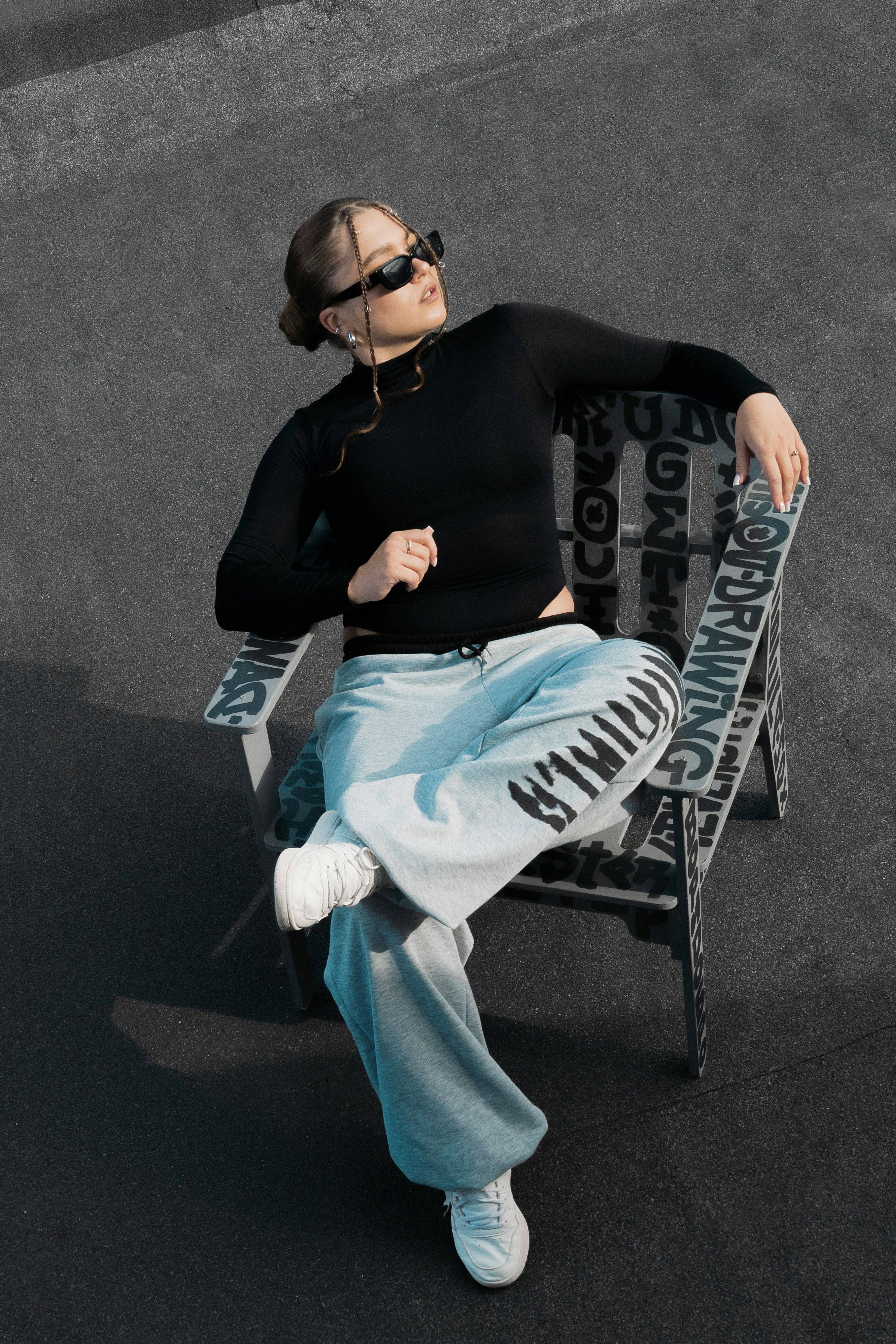 Relaxed Street Couture: A Confident Pose on Graphic Armchair