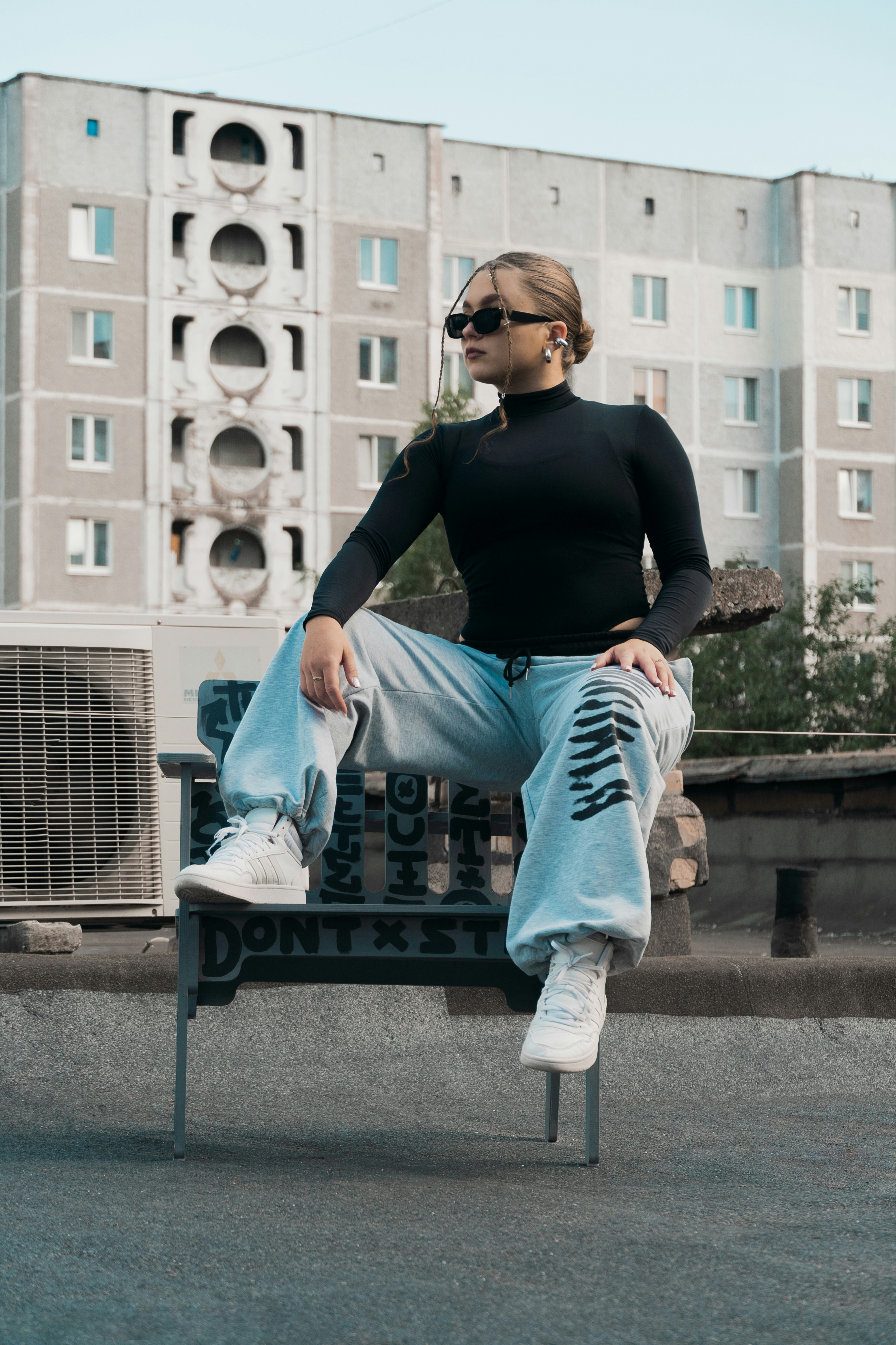Urban Stance: A confident pause on a rooftop stage