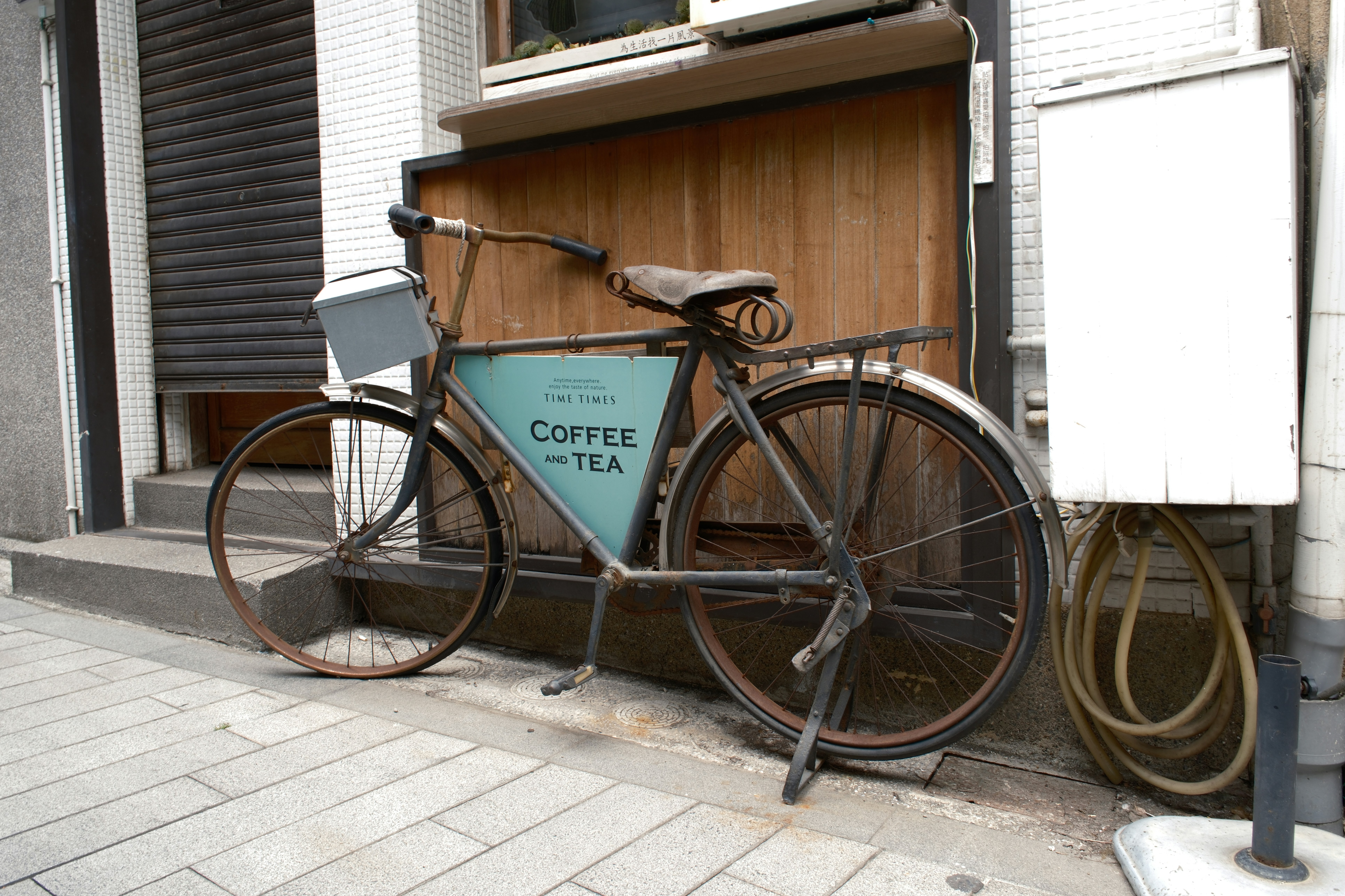 Vintage Bicycle Leaning Against a Shopfront with a Turquoise Coffee Sign