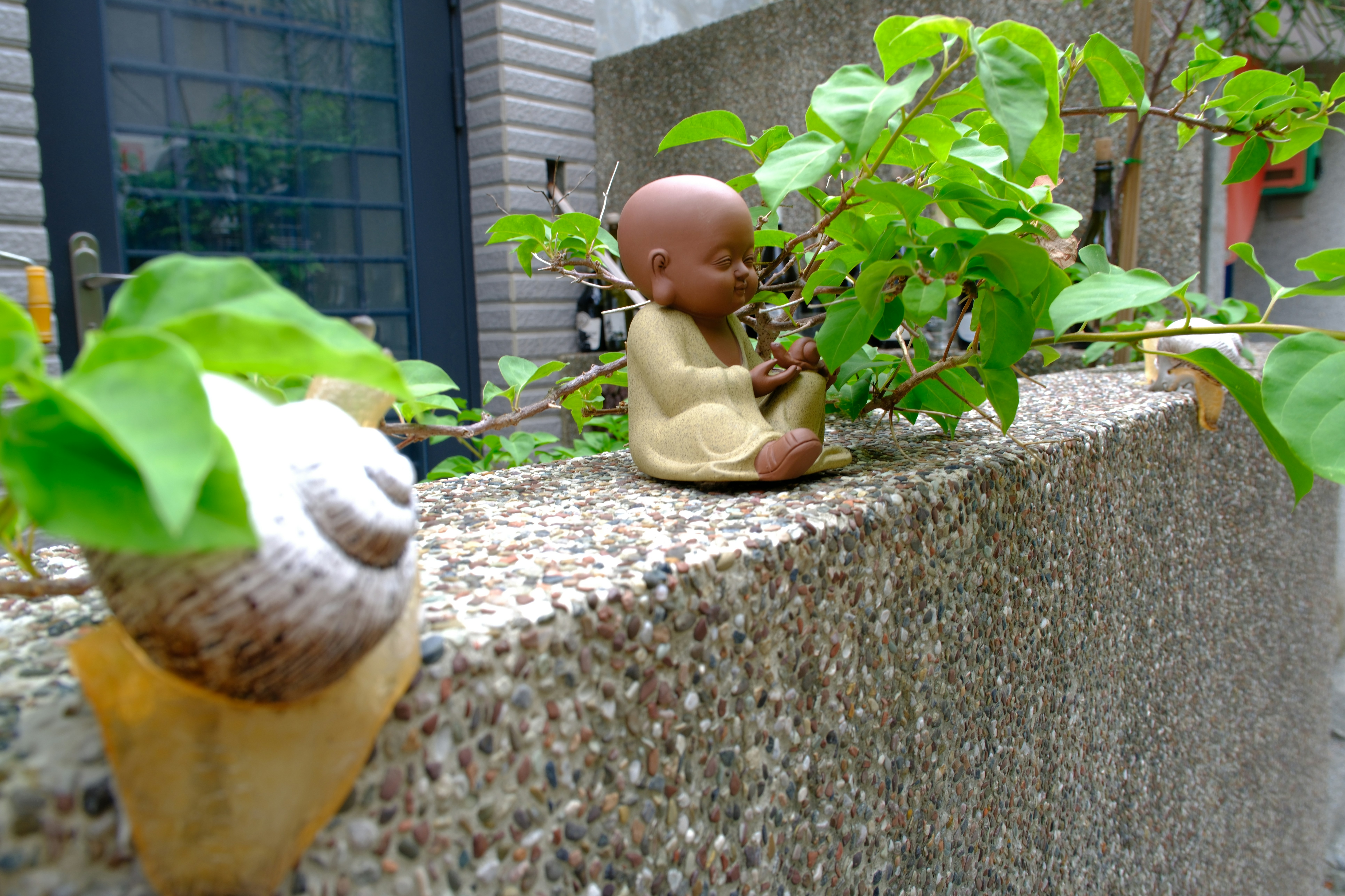 Tiny Guardian on the Concrete Ledge