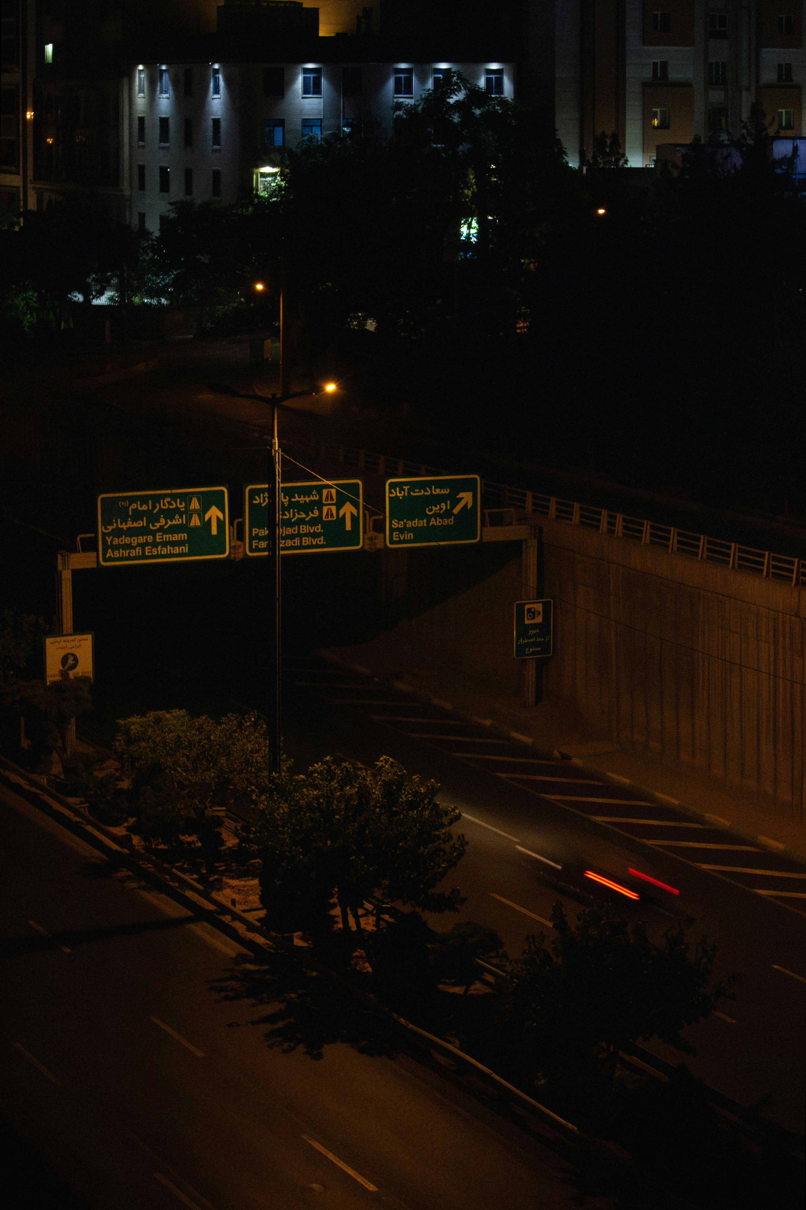 Night Signage Arc: A Quiet Street Illuminated by Street Lamps