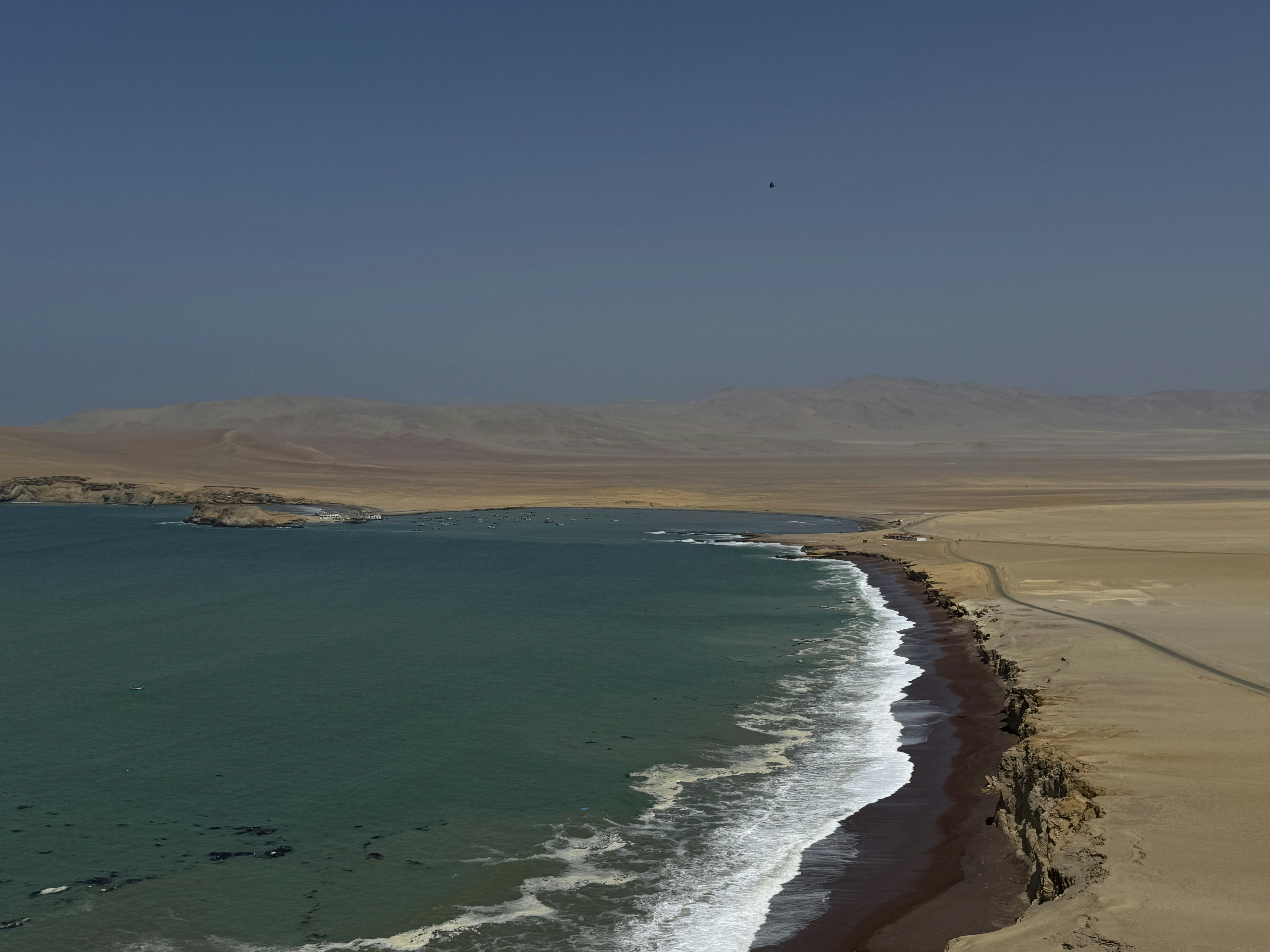 Desert shoreline: turquoise sea meeting wind-swept sands