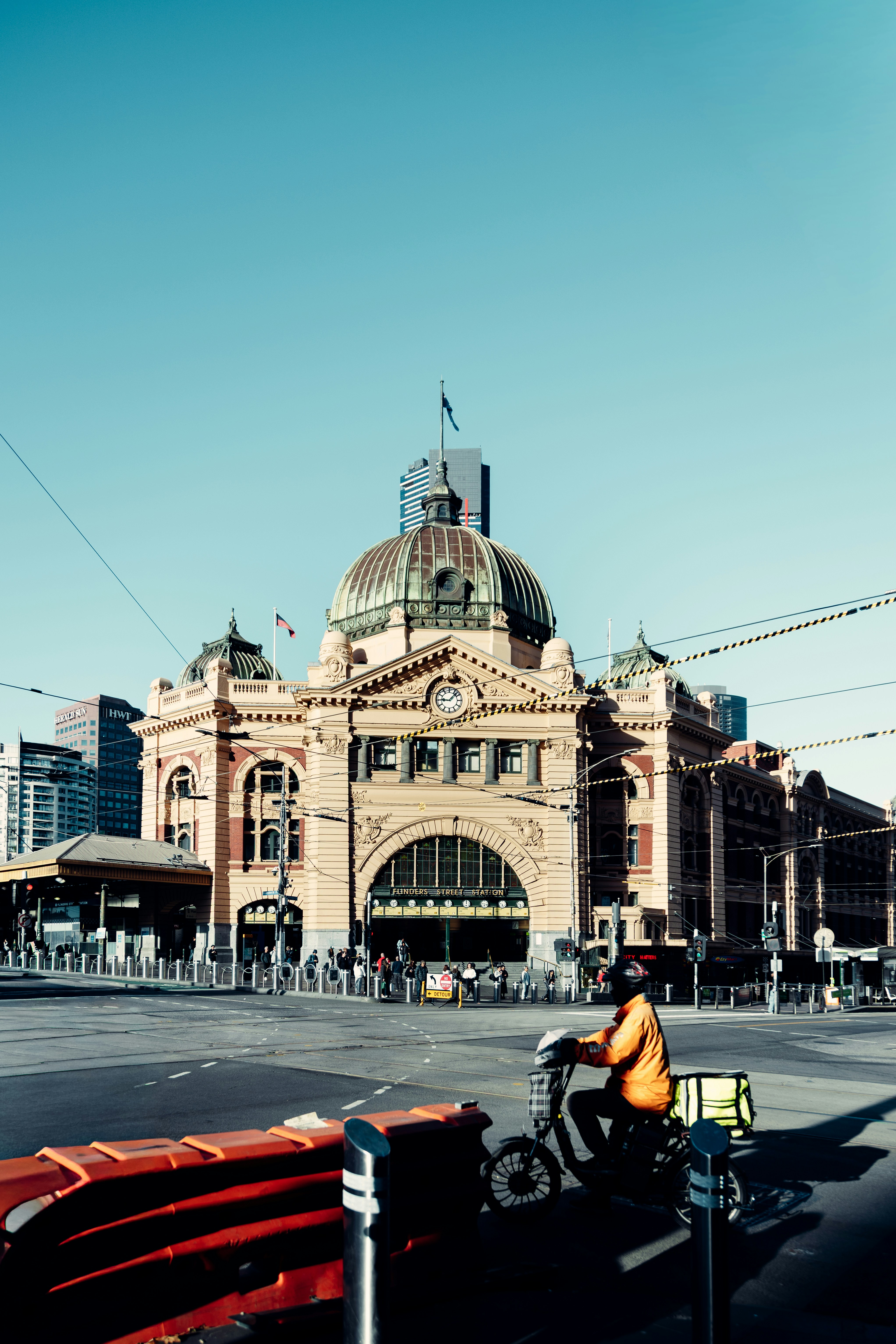 City Hall in Focus: Dome, Arched Entrance, and the Moving Rider