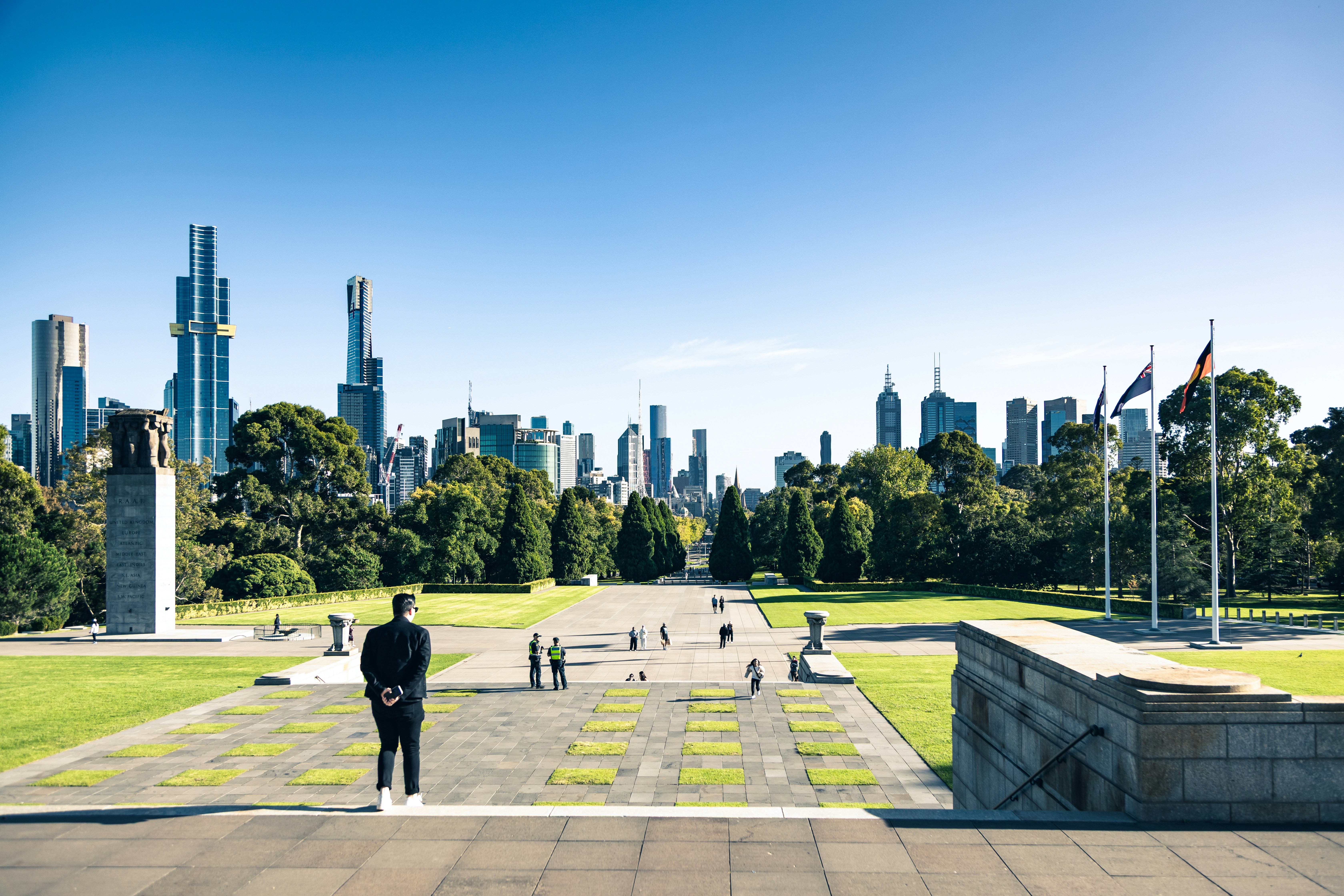Symmetry Across the Lawn: City Skyline Framed by Treeline