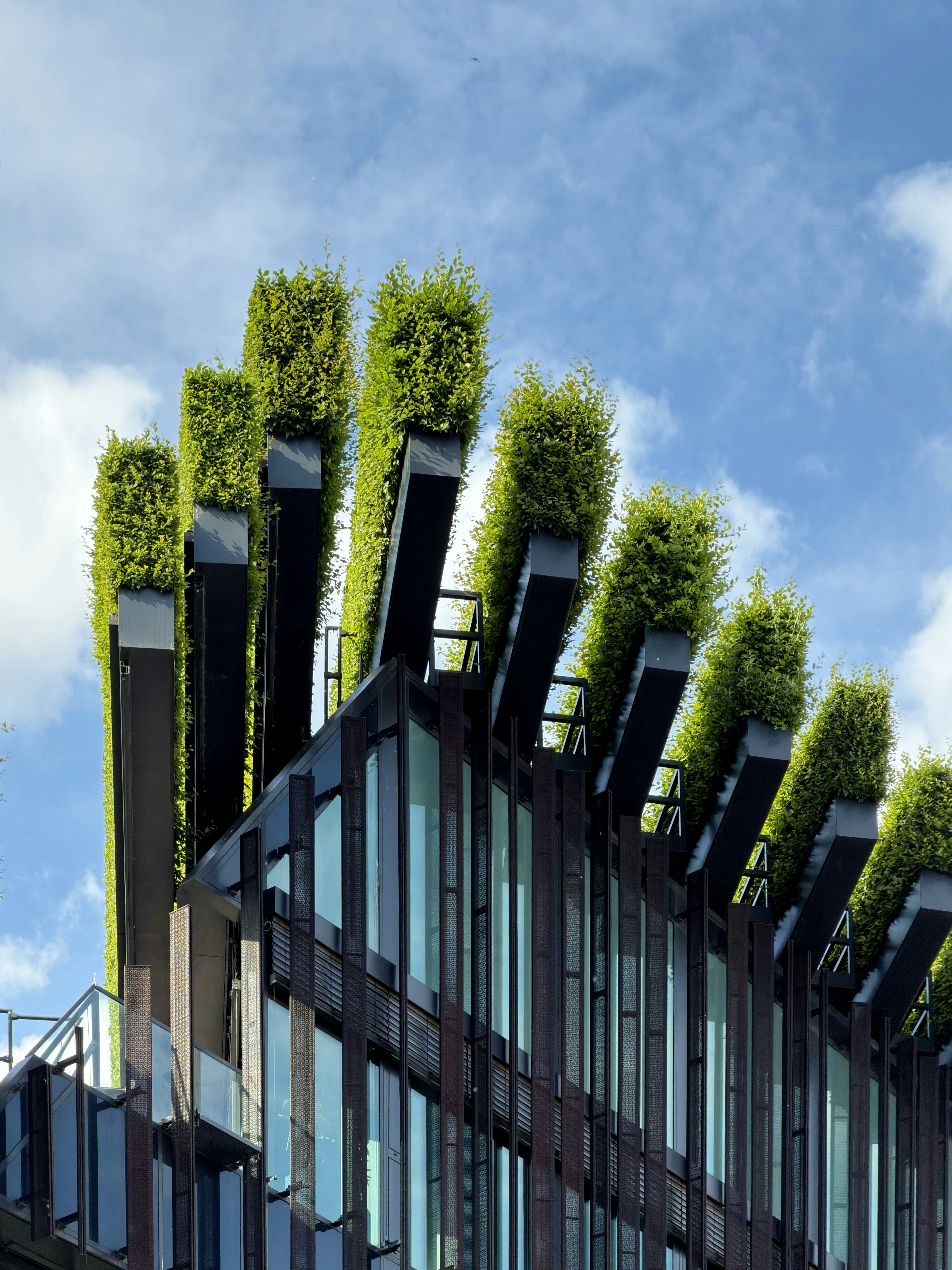 Vertical Gardens Crown a Modern Glass Facade