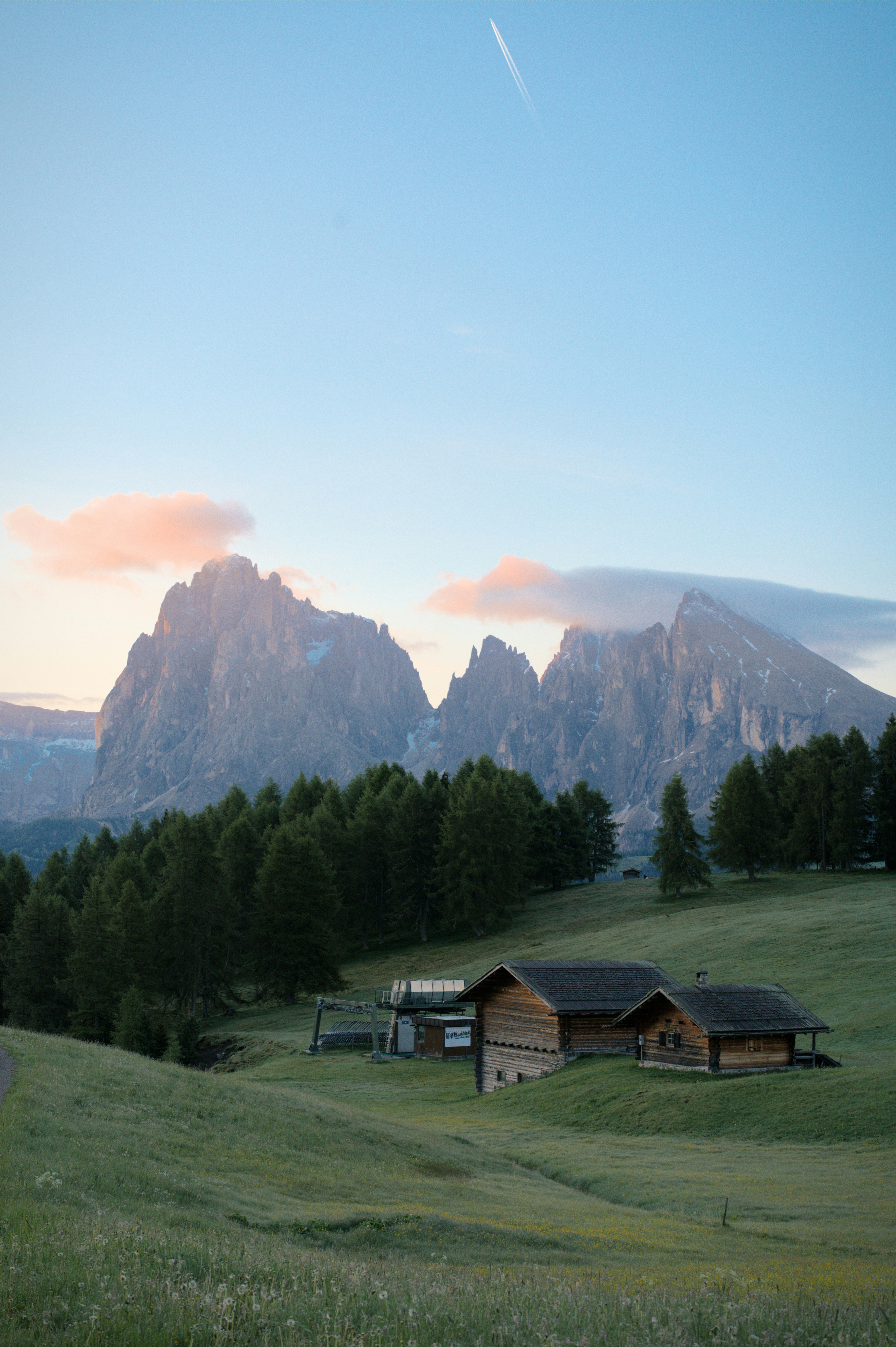 Sunlit Peaks Over a Quiet Mountain Cabin