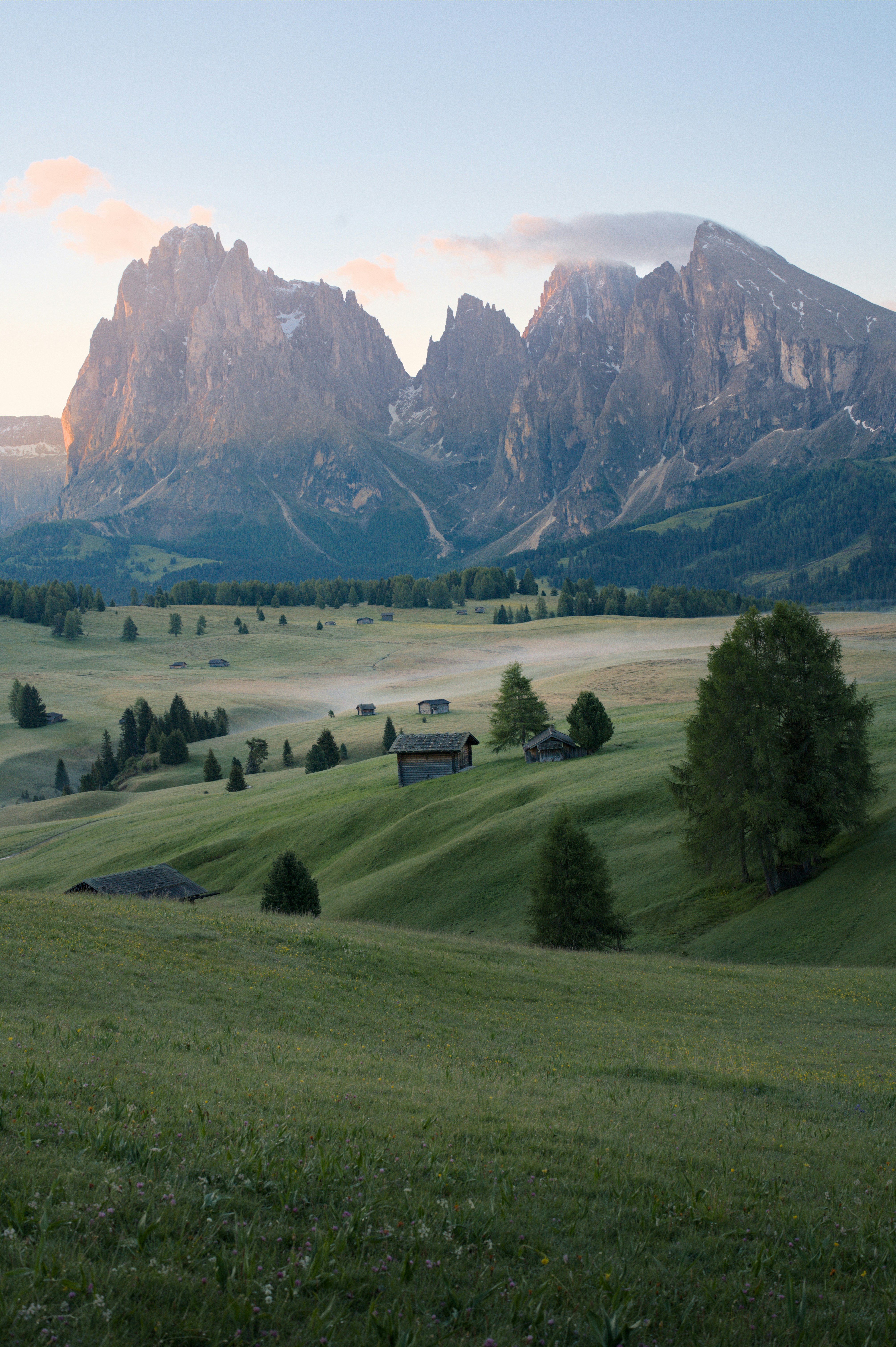 Pastoral Valley Beneath the Jagged Peaks at Dusk