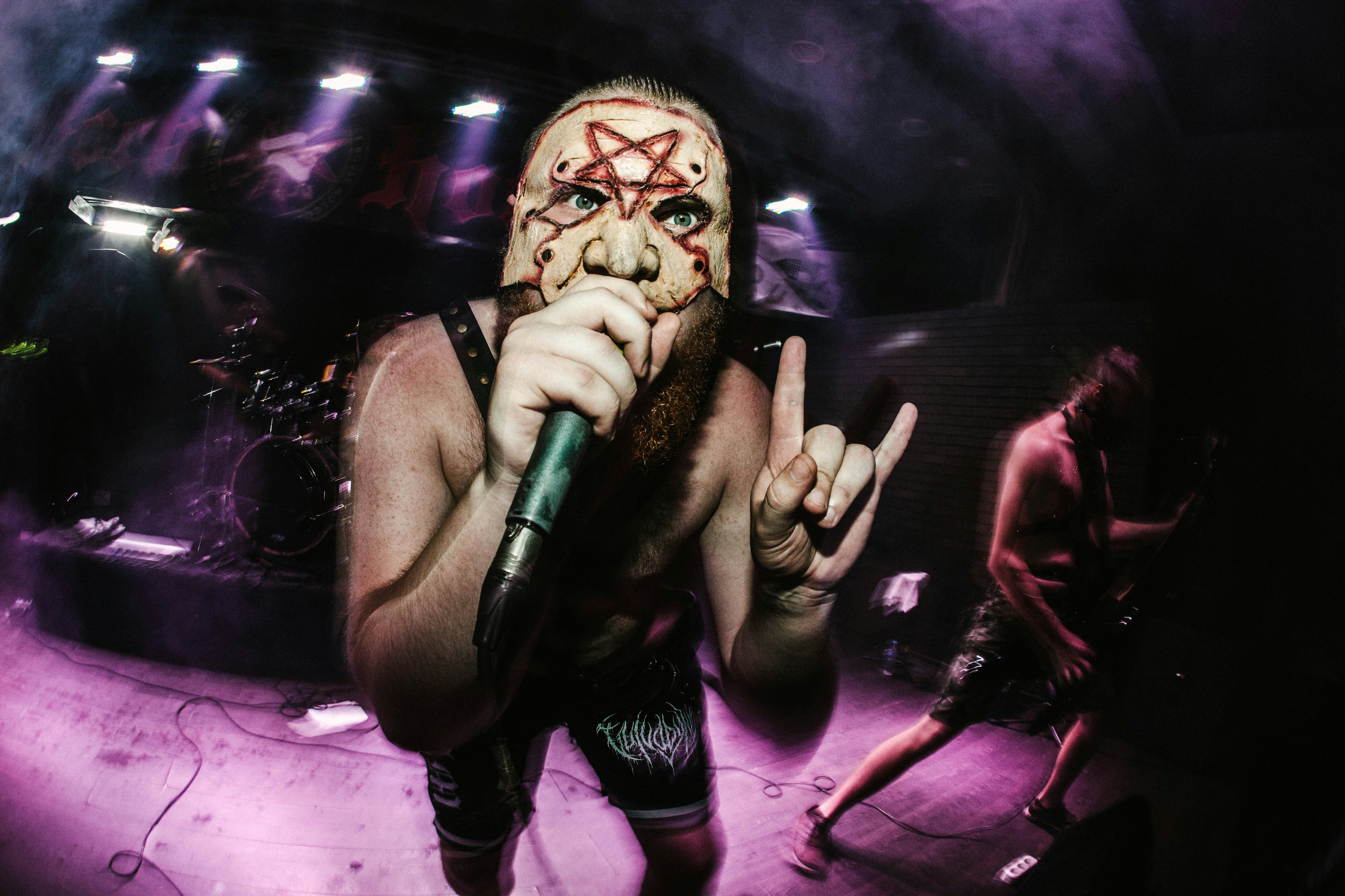 Mask, Microphone, and Mayhem: A Frontman’s Grit in the Spotlight