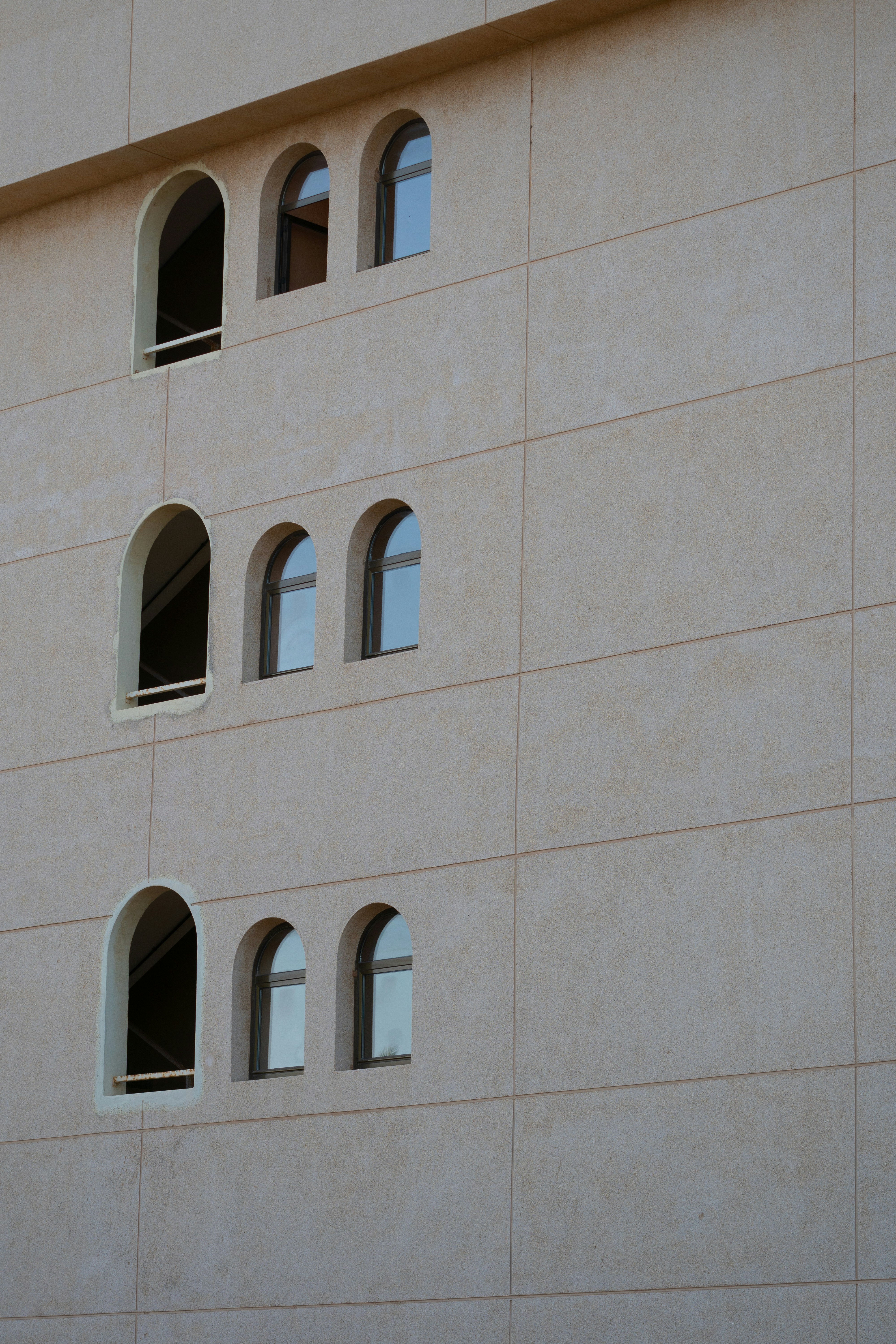 Row of Arch Windows on a Beige Facade
