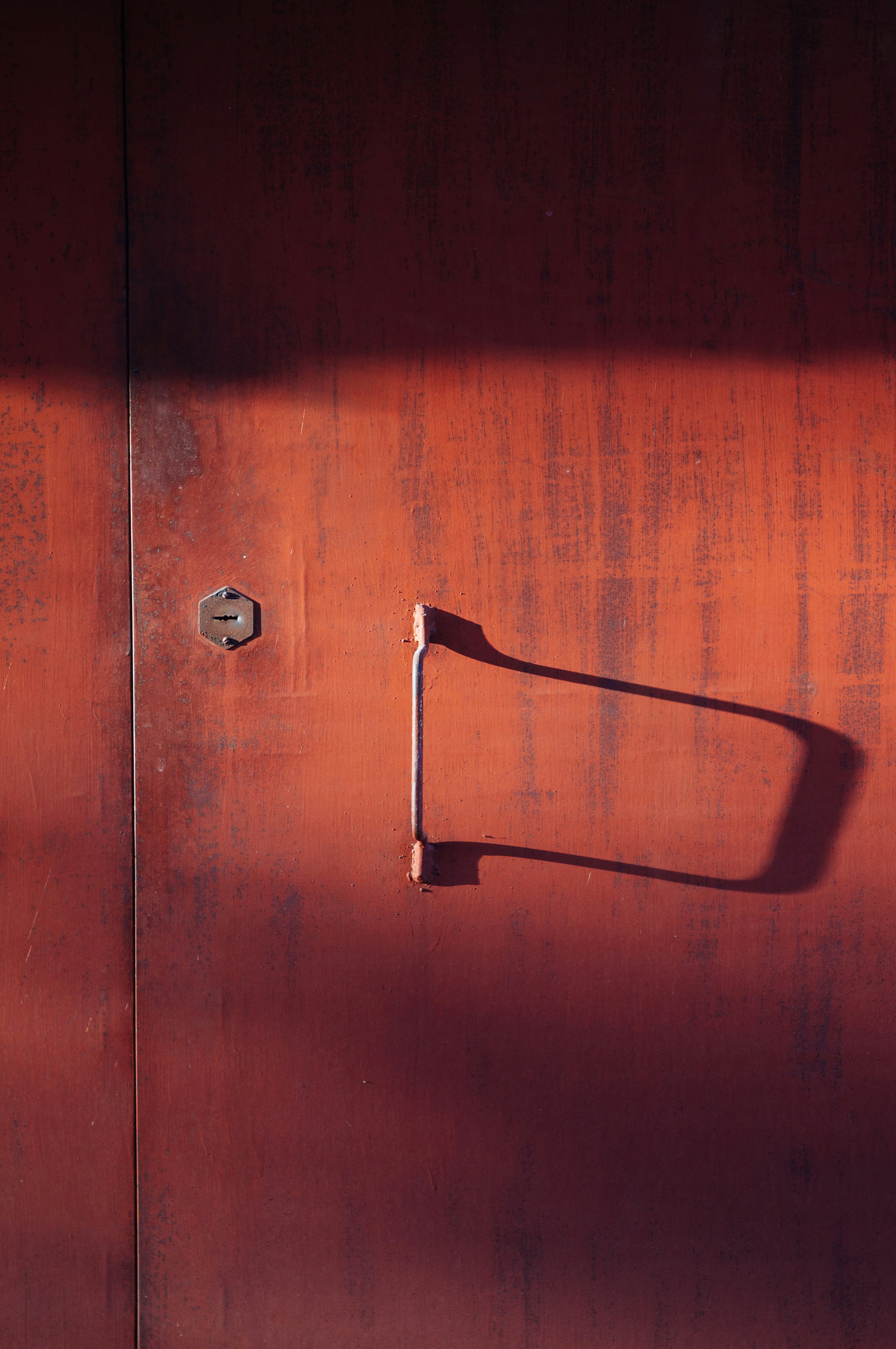 Rusty hinge and shadow: a quiet doorway in late light