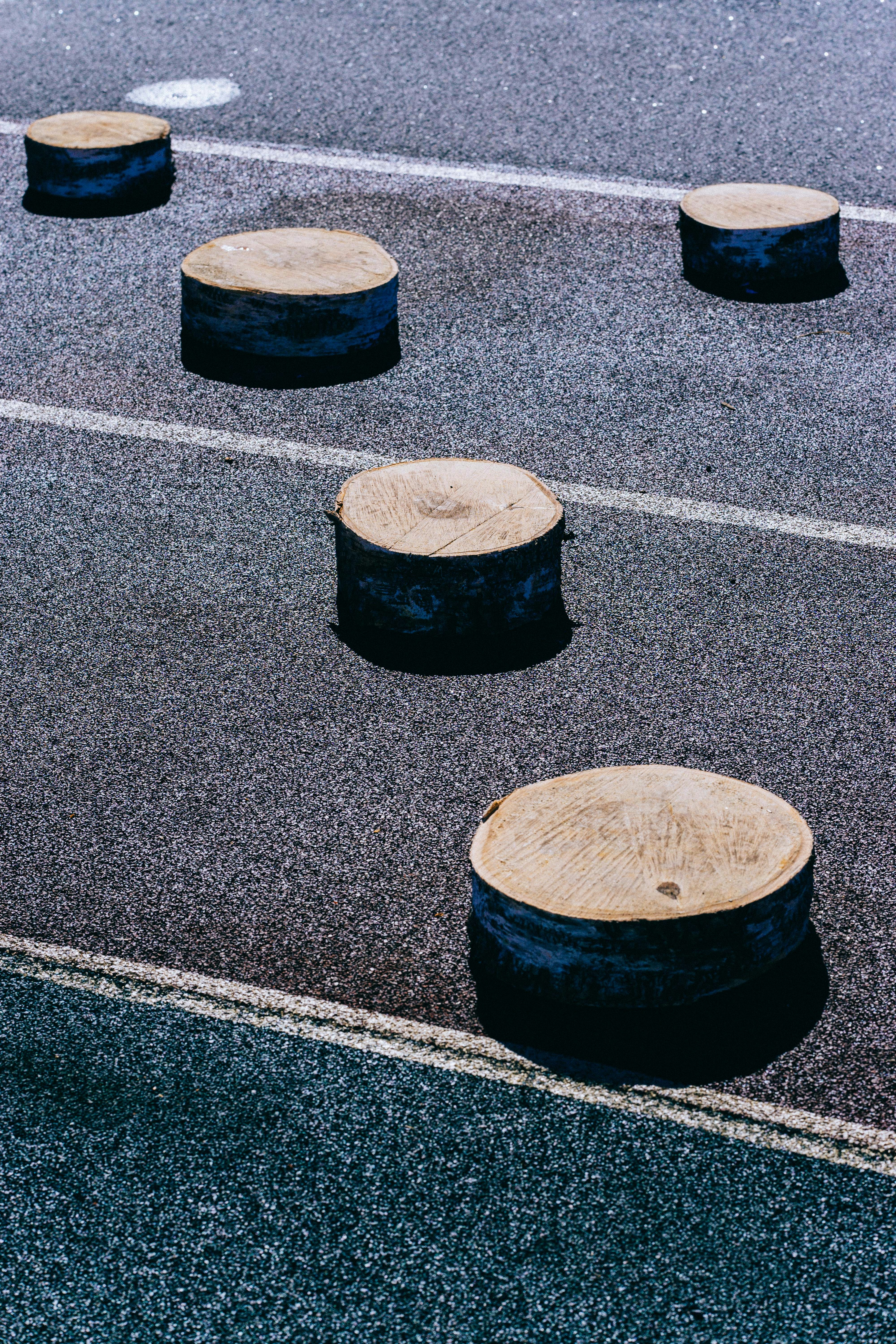 Circular wooden stumps in a sunlit playground