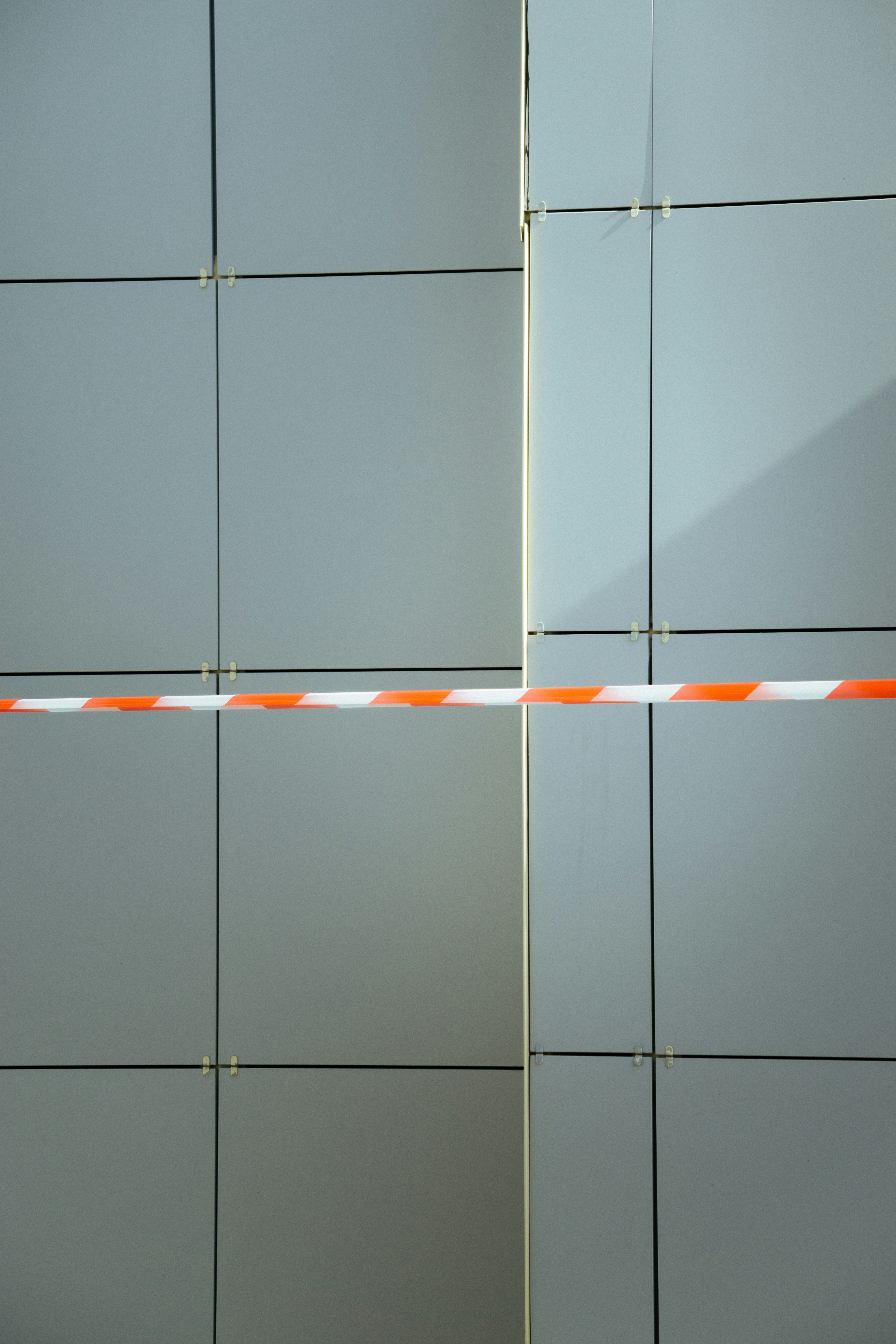 Minimal Barrier: Scarce Color Stripes Across a Geometric Facade