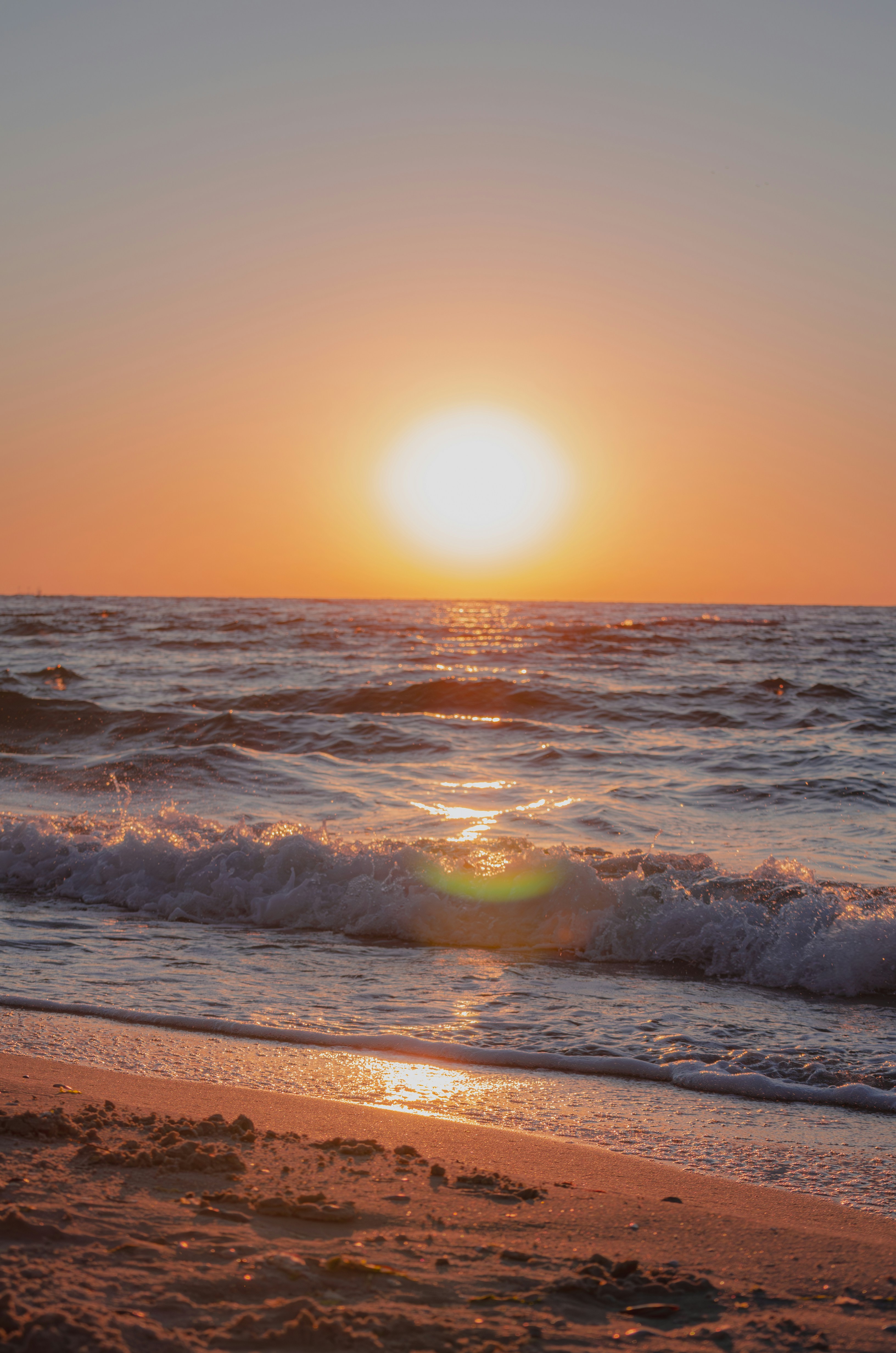 Sunlit Crest: A Serene Beach at Dusk
