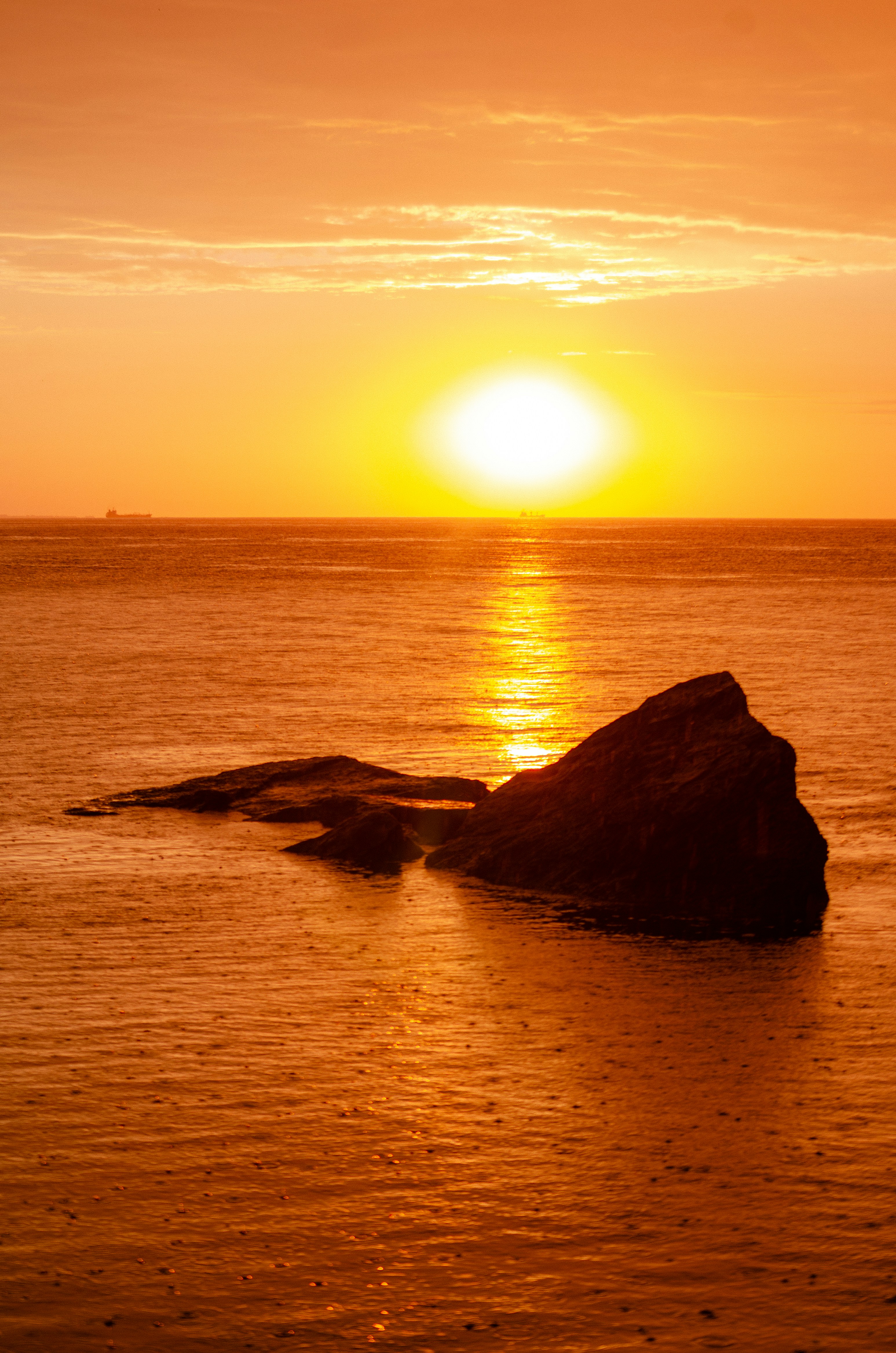 Sunlit Rock Sentinel at Dusk over a Calm Sea