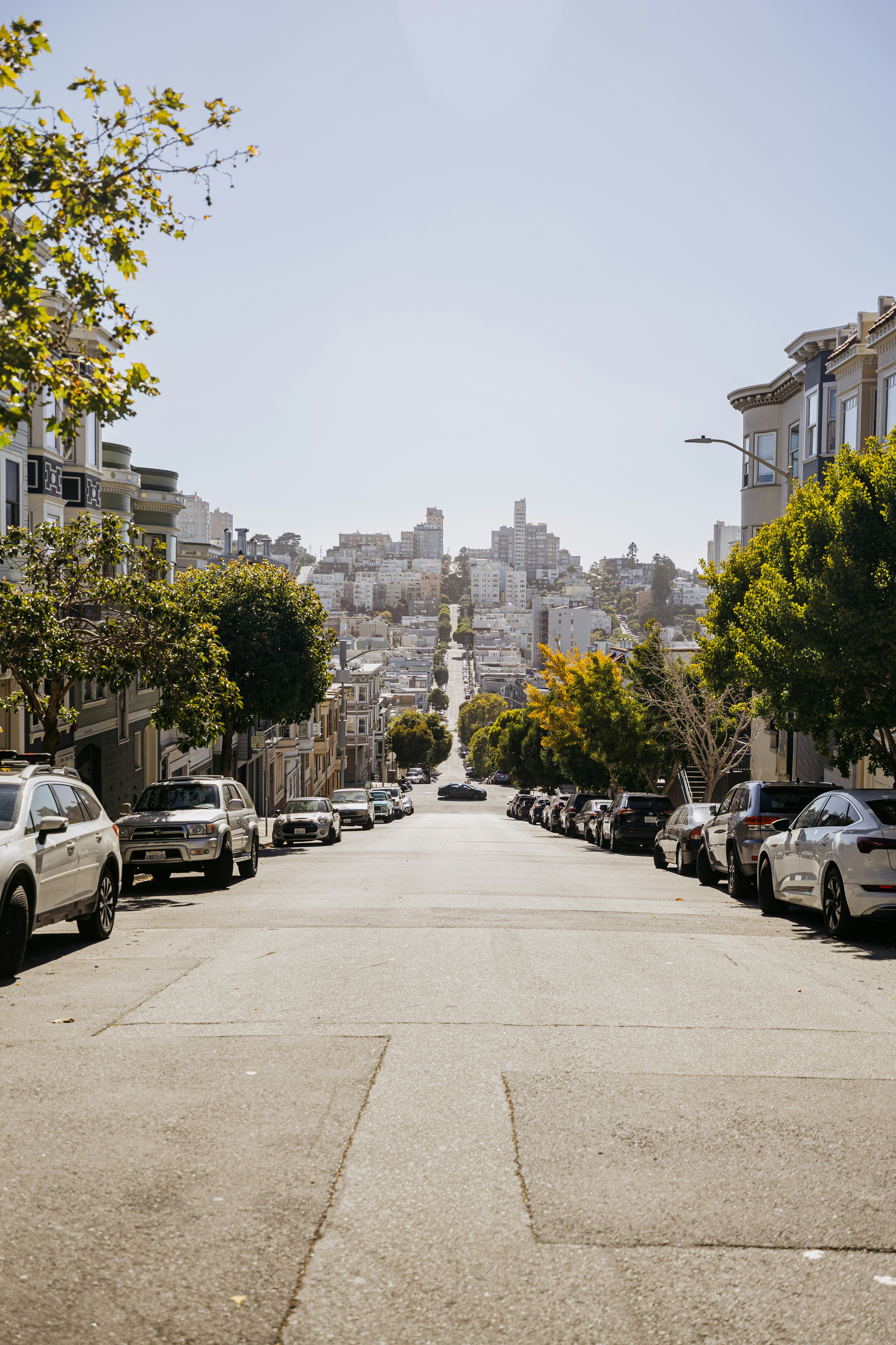 City Steps: A Sunlit Street Leading to a Hillside Skyline