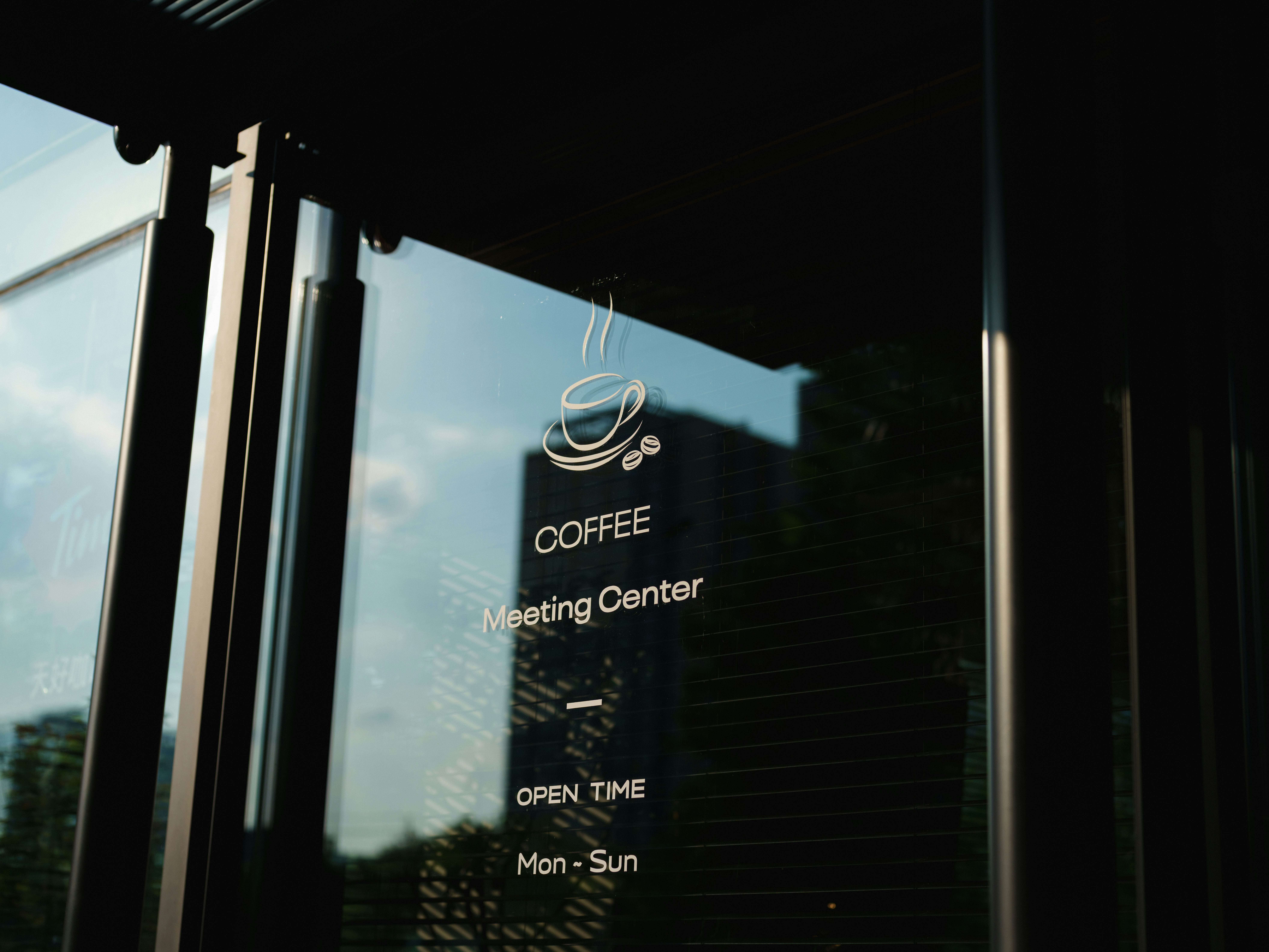 Glass Café Signage Reflections: Quiet Meeting Center in Dusk Glass