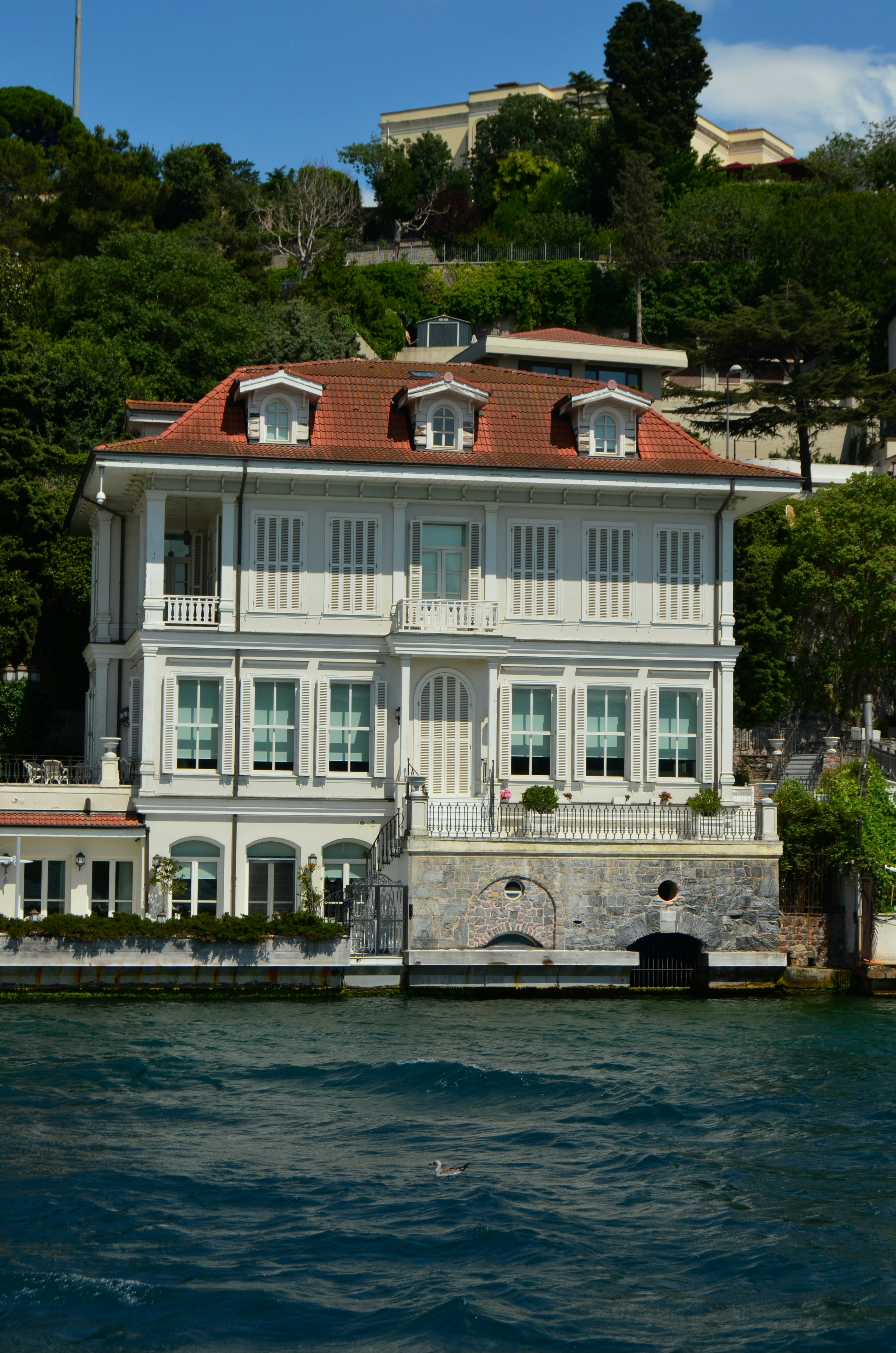 White seaside villa rising from the water’s edge