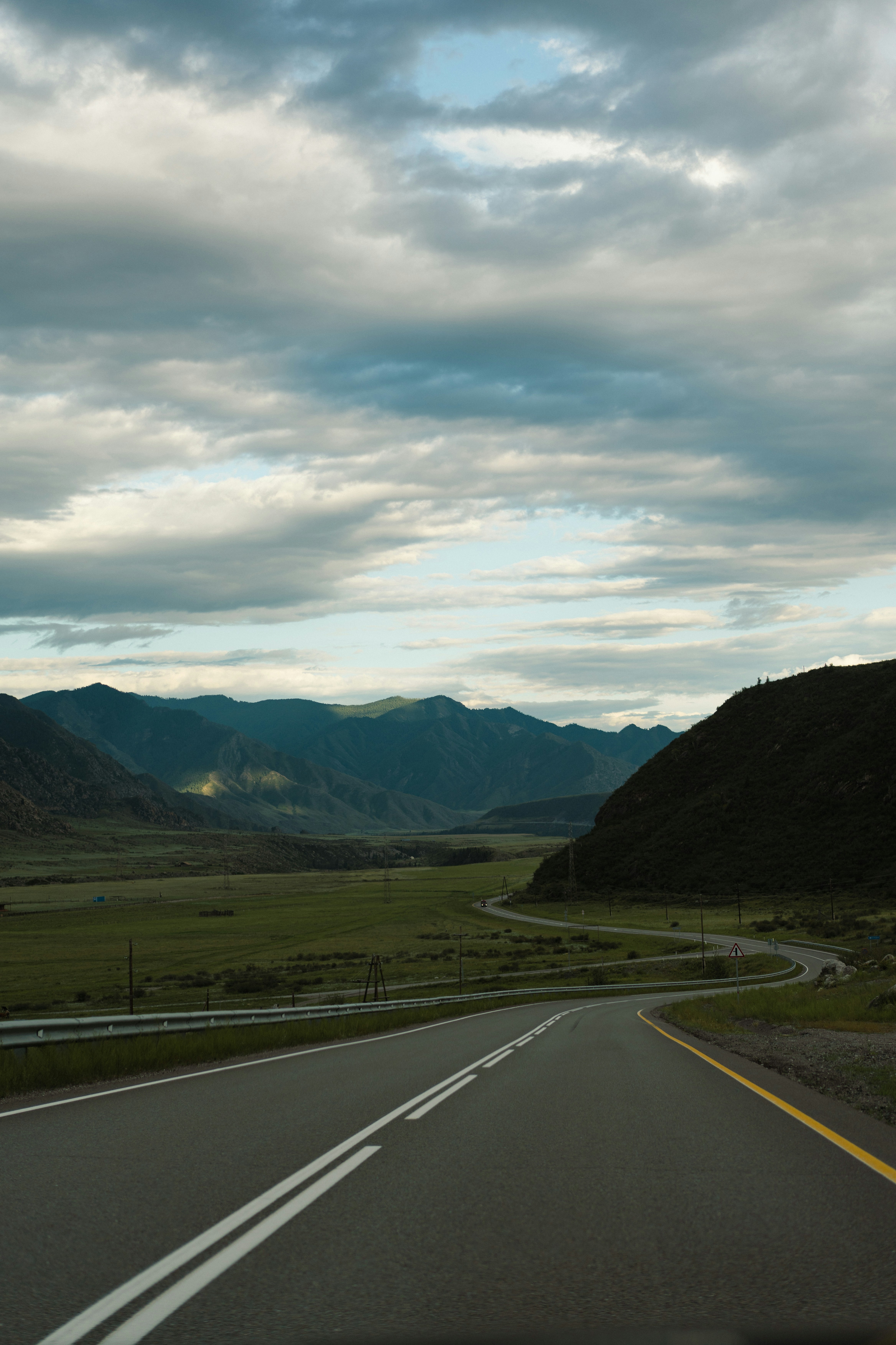 Winding Road Toward the Valley Beyond the Hills
