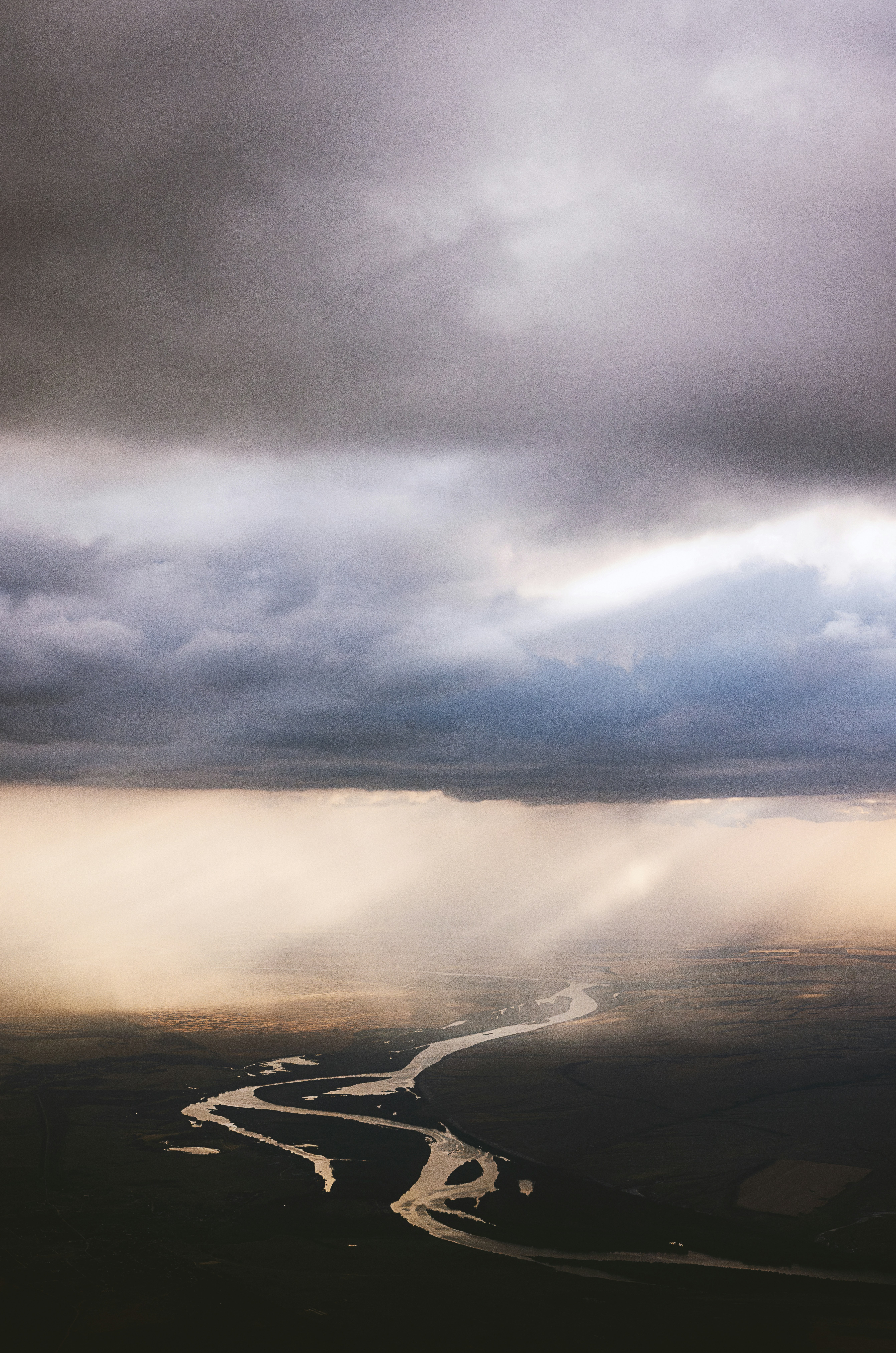Riversong in the Sky: Beams Piercing a Sunset Valley
