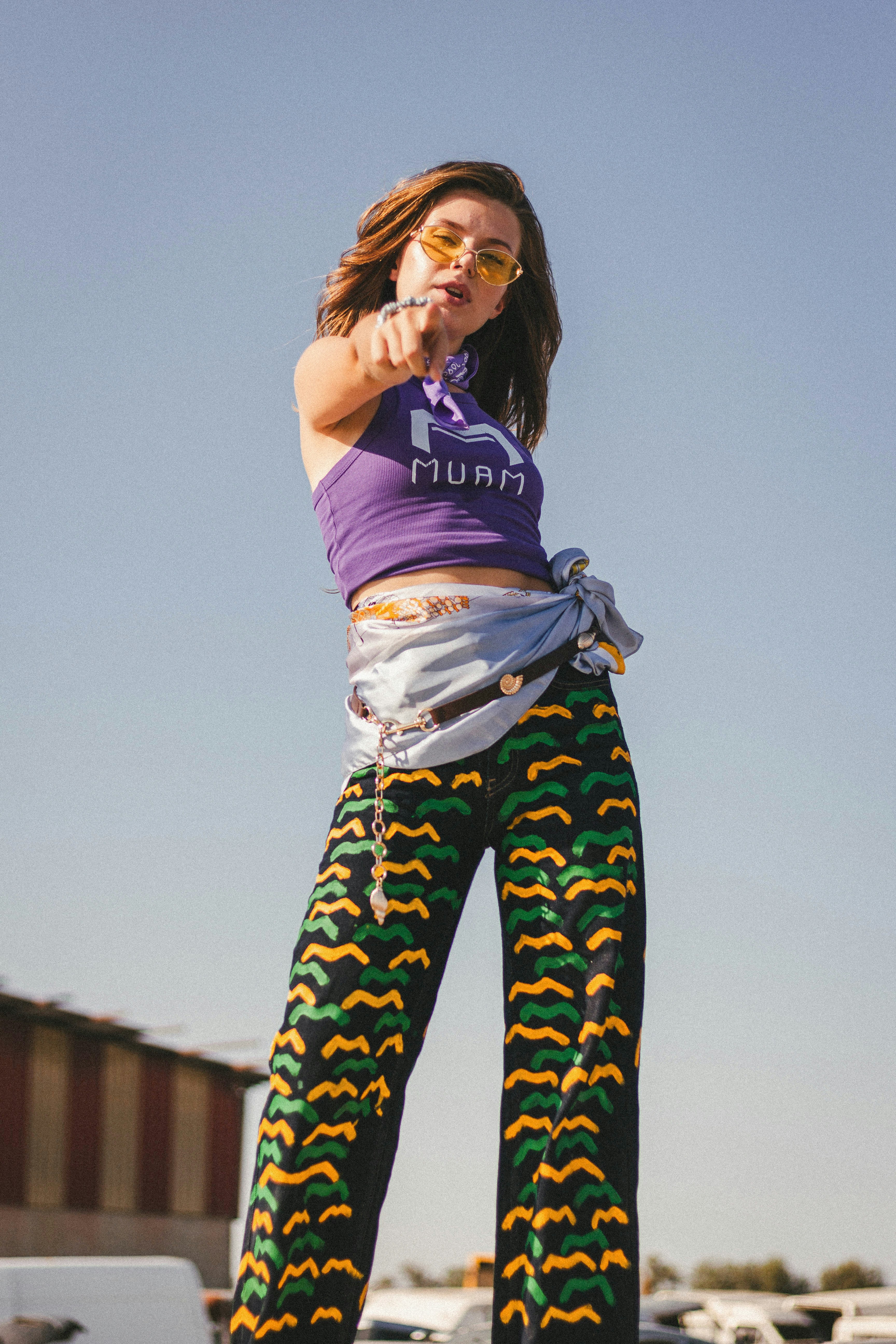 Pointing Confidence: A sunlit stance in vibrant streetwear