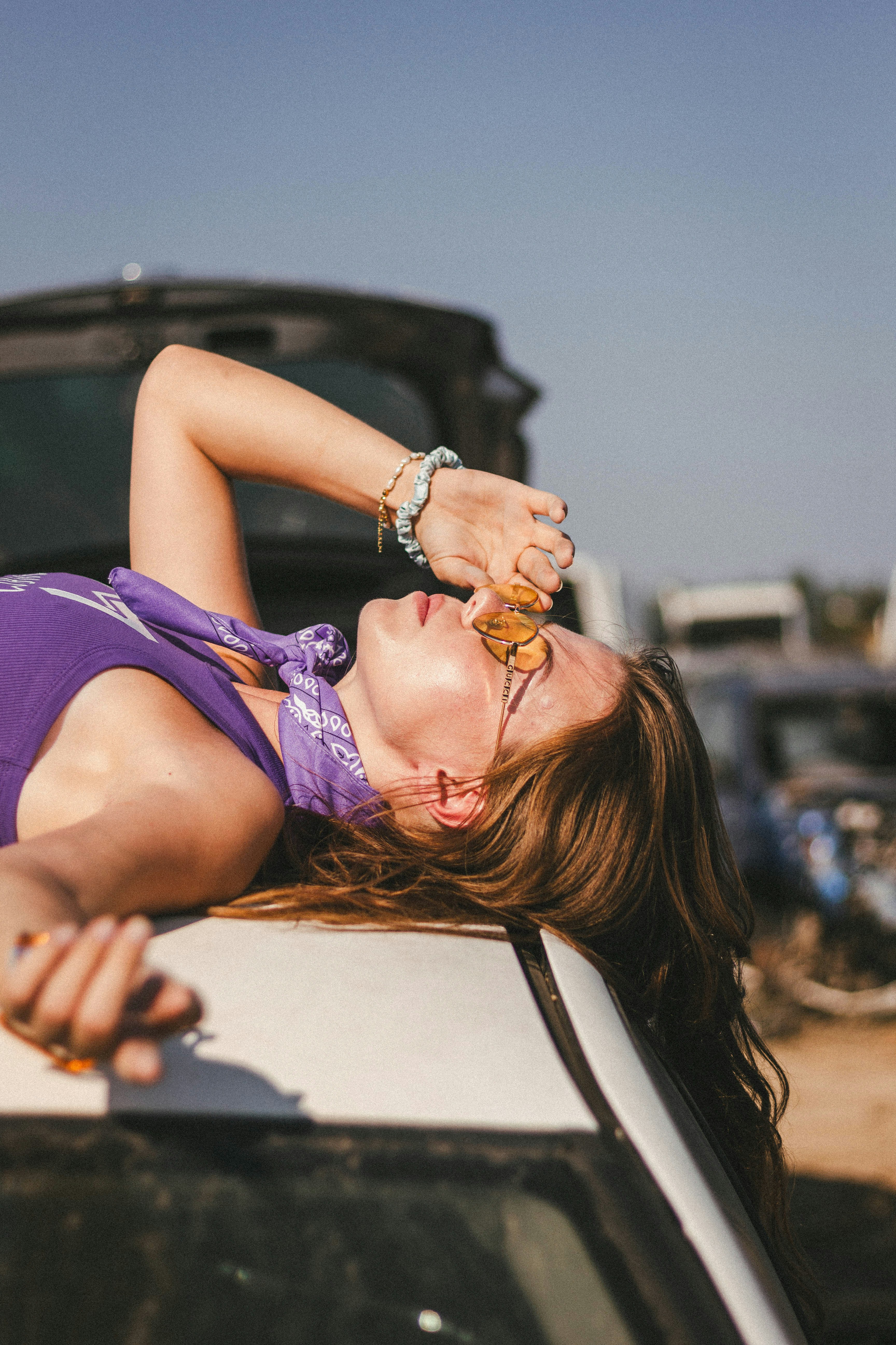 Sunlit Repose: A Moment of Contemplation on a Moving Car Hood
