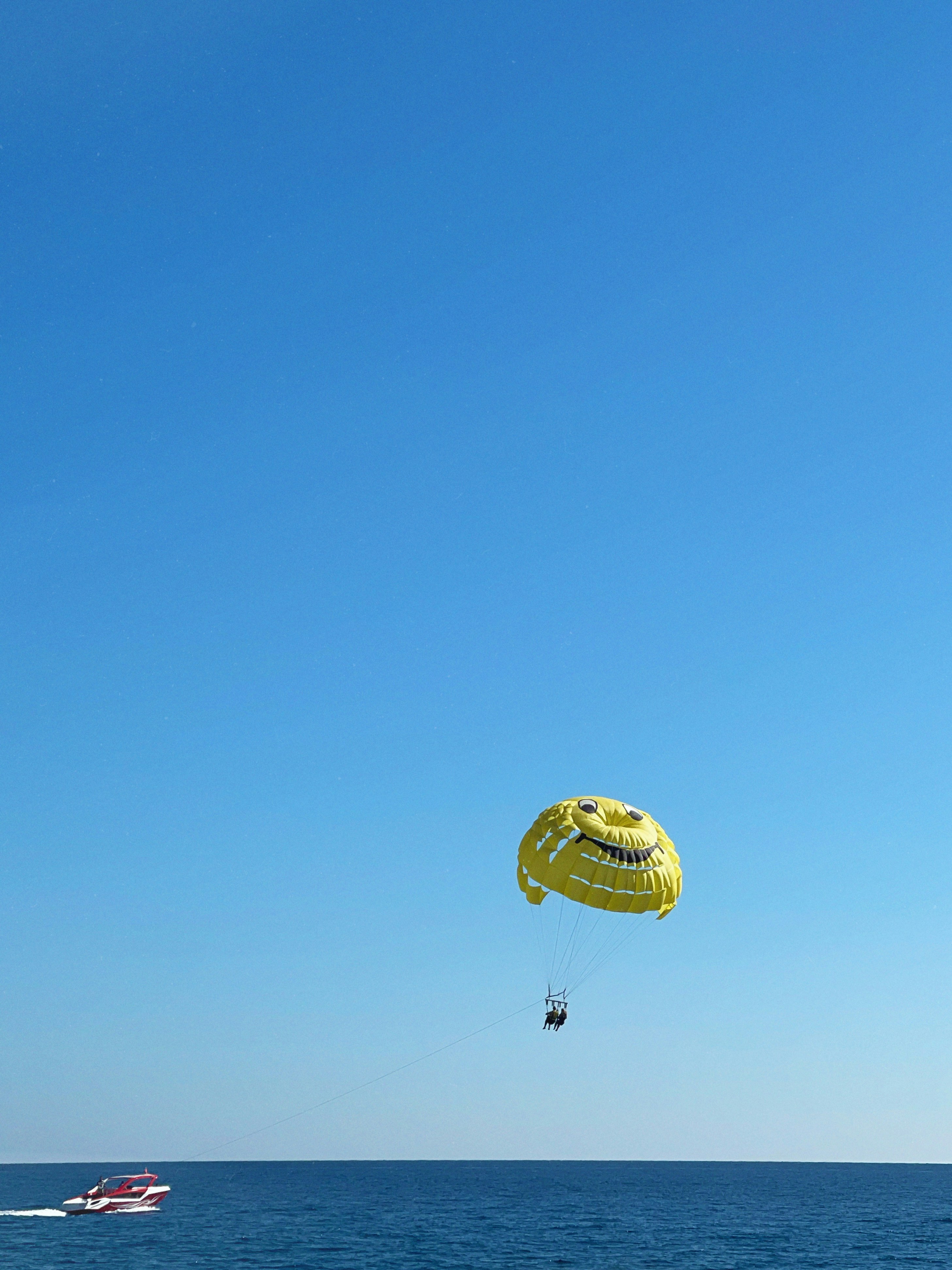 Yellow parasail against a vast sea and sky
