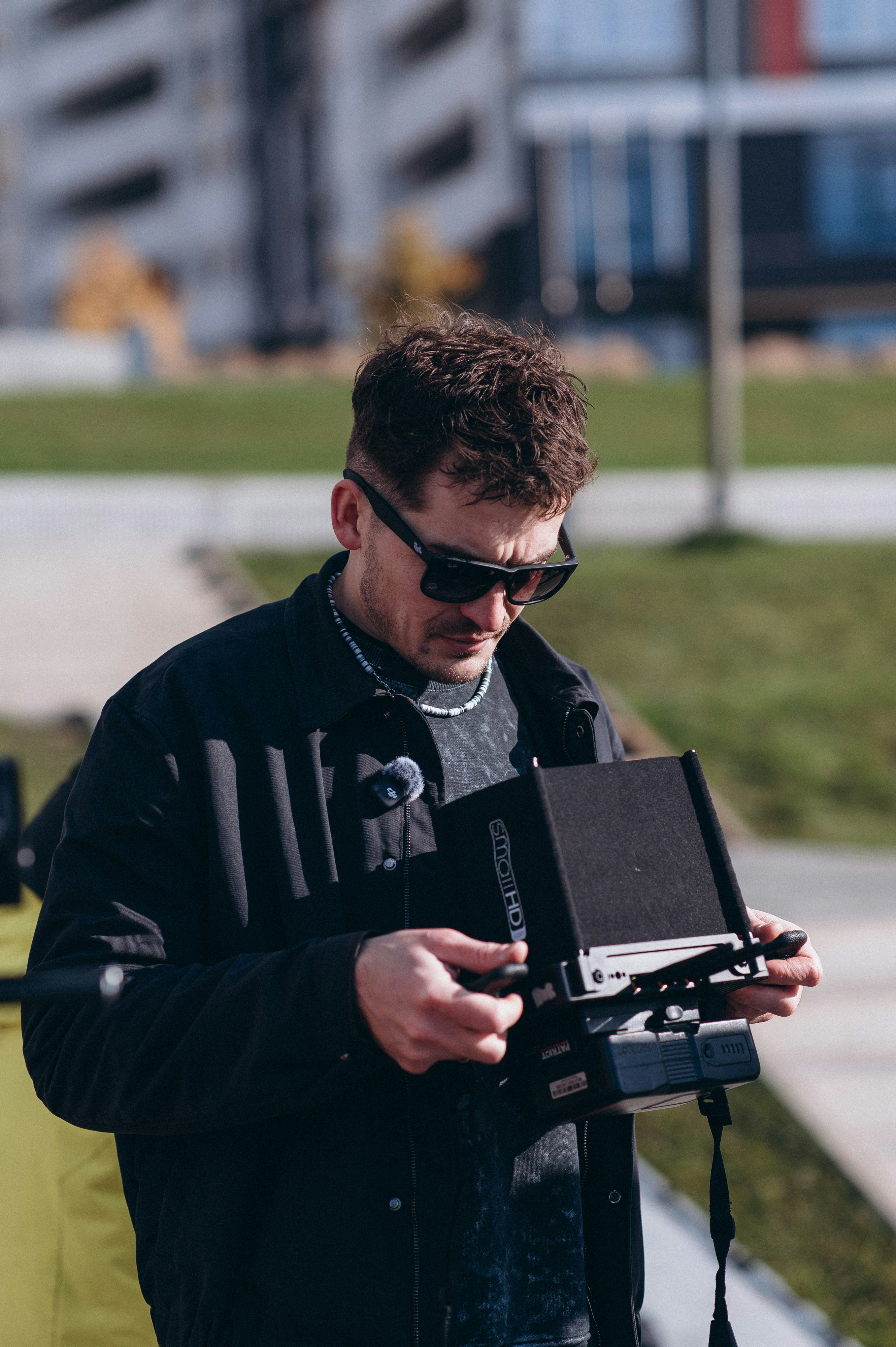 Operator with Retro Cine Setup Captured in Outdoor Daylight