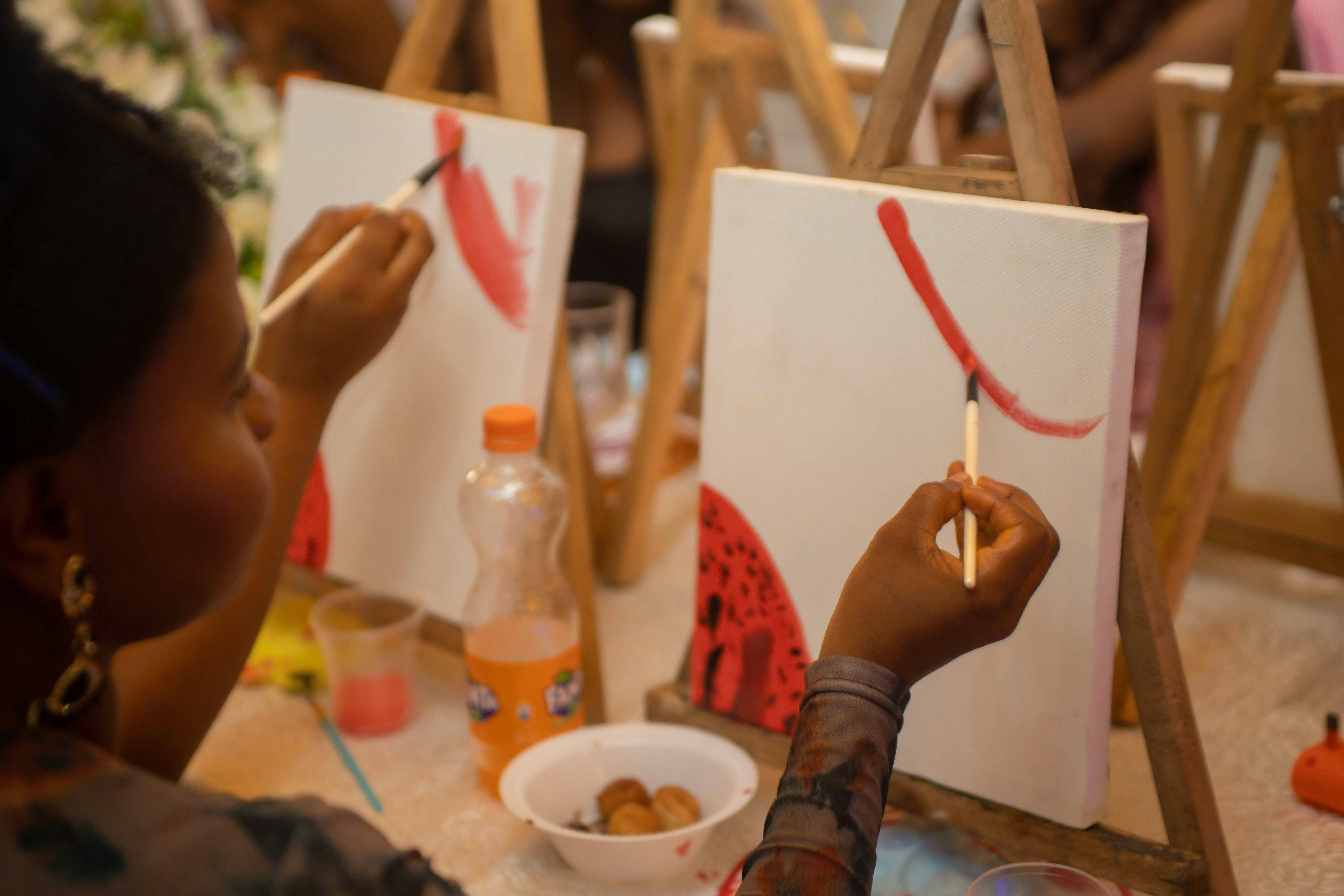 Brushstroke Exchange: Hands and Canvas in a Shared Studio Moment
