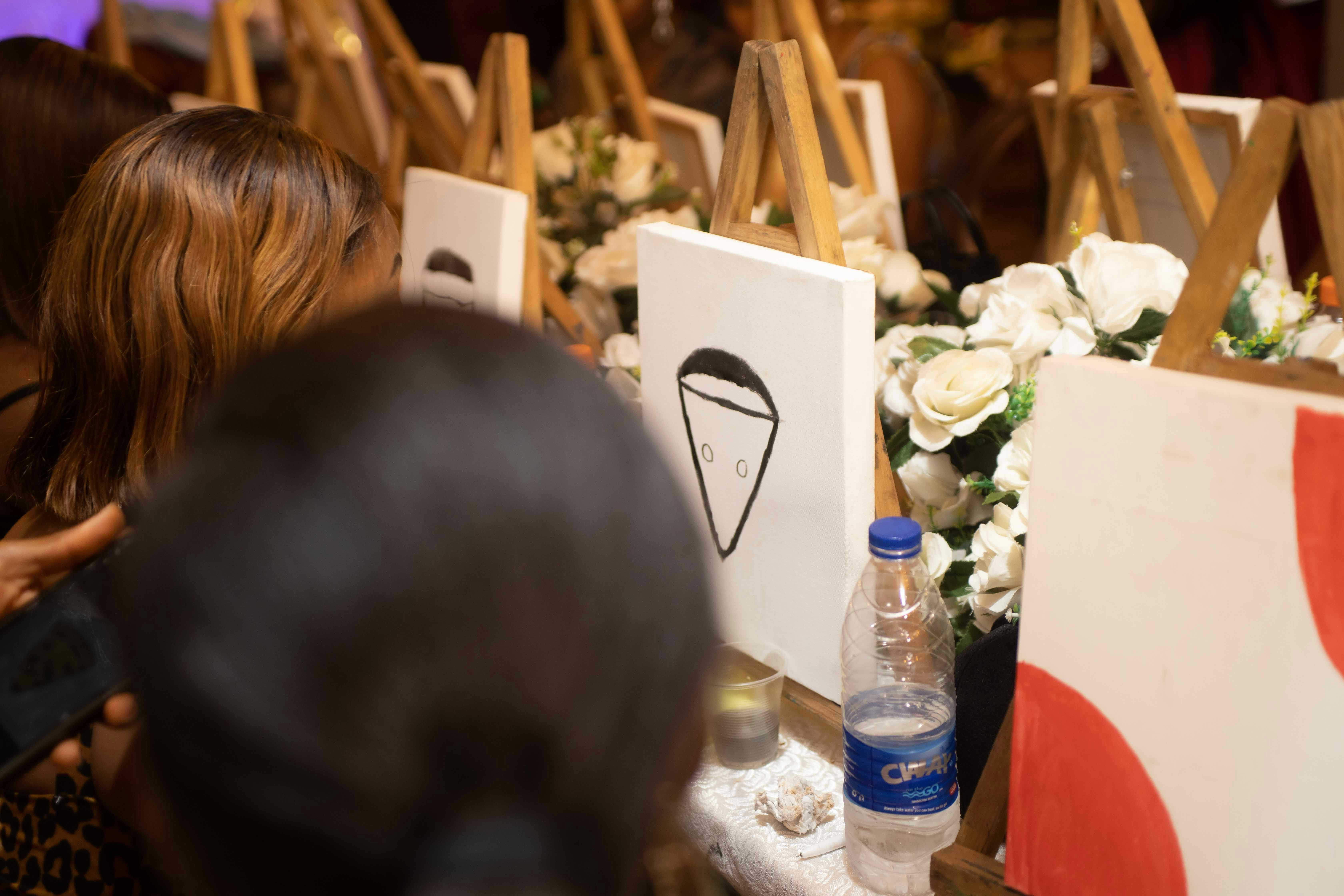 Portrait of a Quiet Exhibit Row: Faces, Flowers, and a Splash of Water