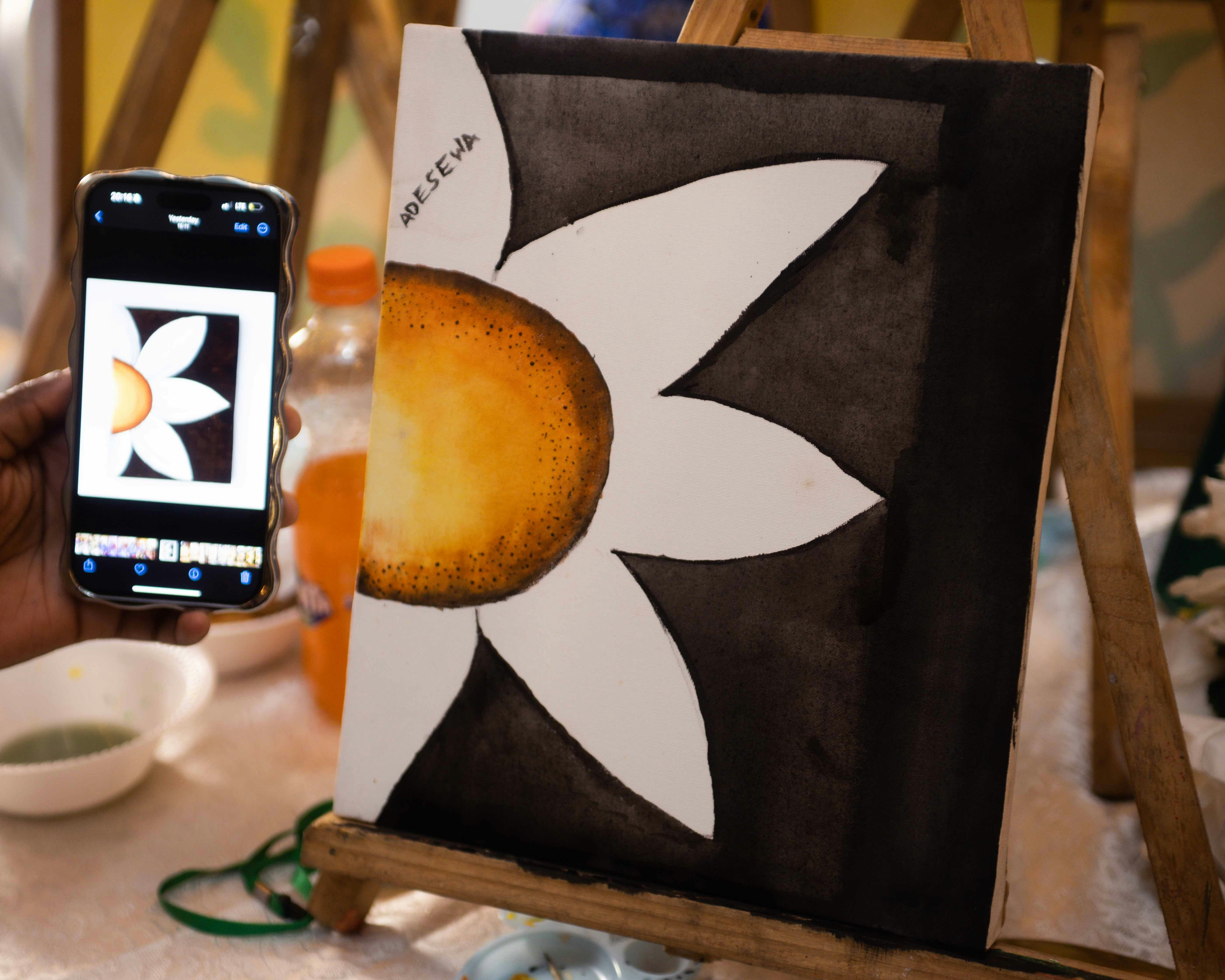 Framed citrus bloom: a painterly canvas beside a smartphone guide