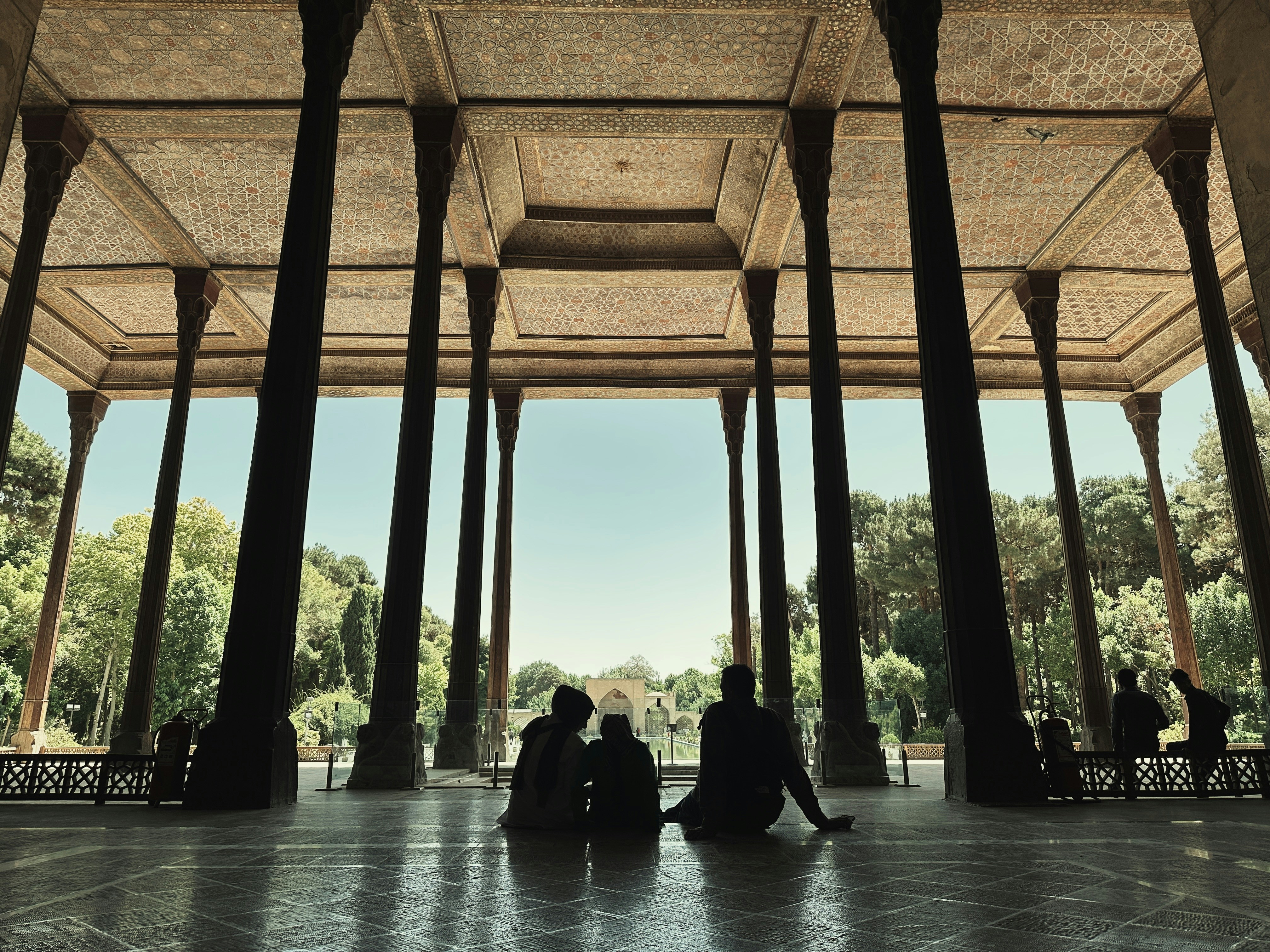 Quiet Silhouettes Beneath an Abstract Pavilion